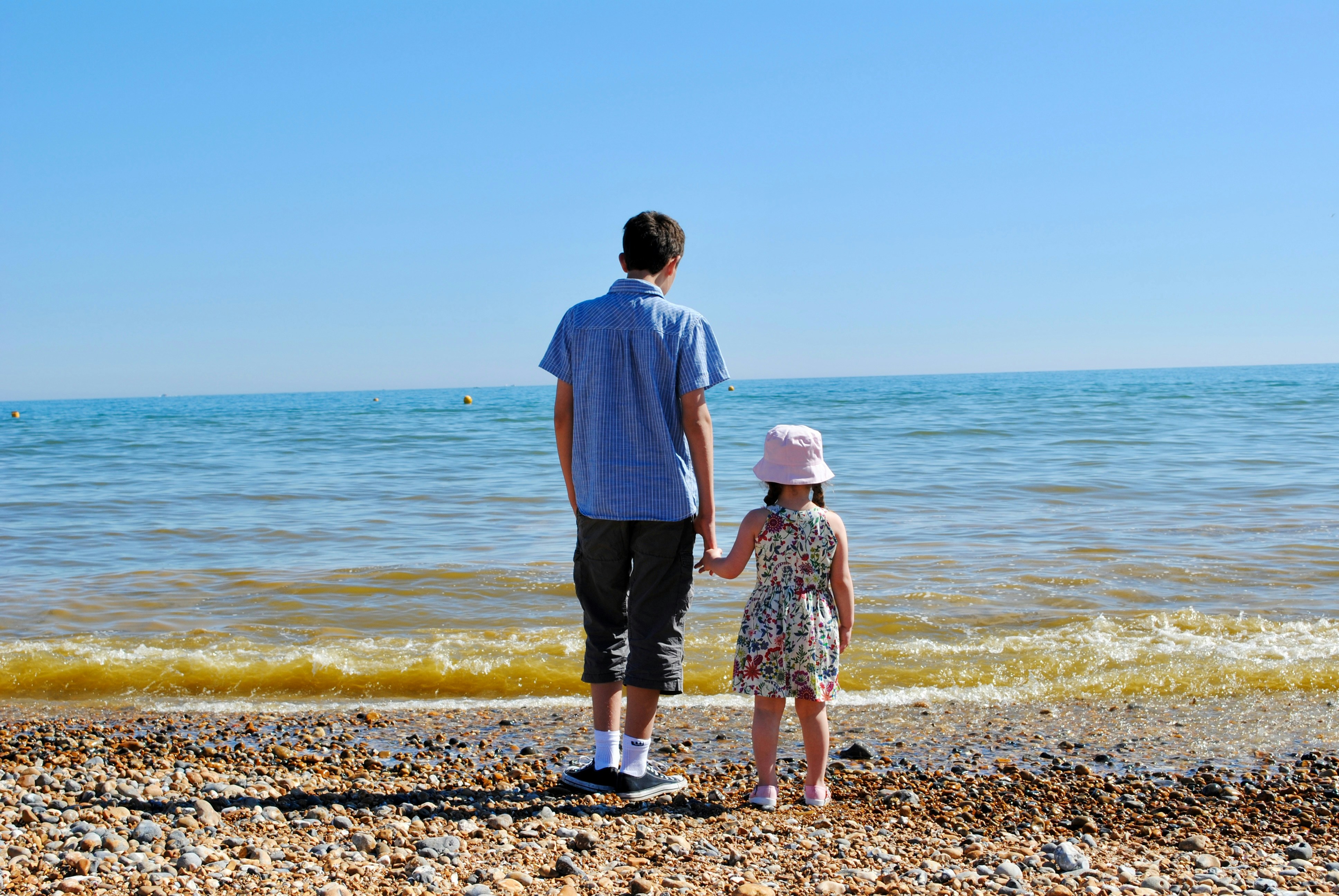 Two by the Shore: A Shared Moment at Sea