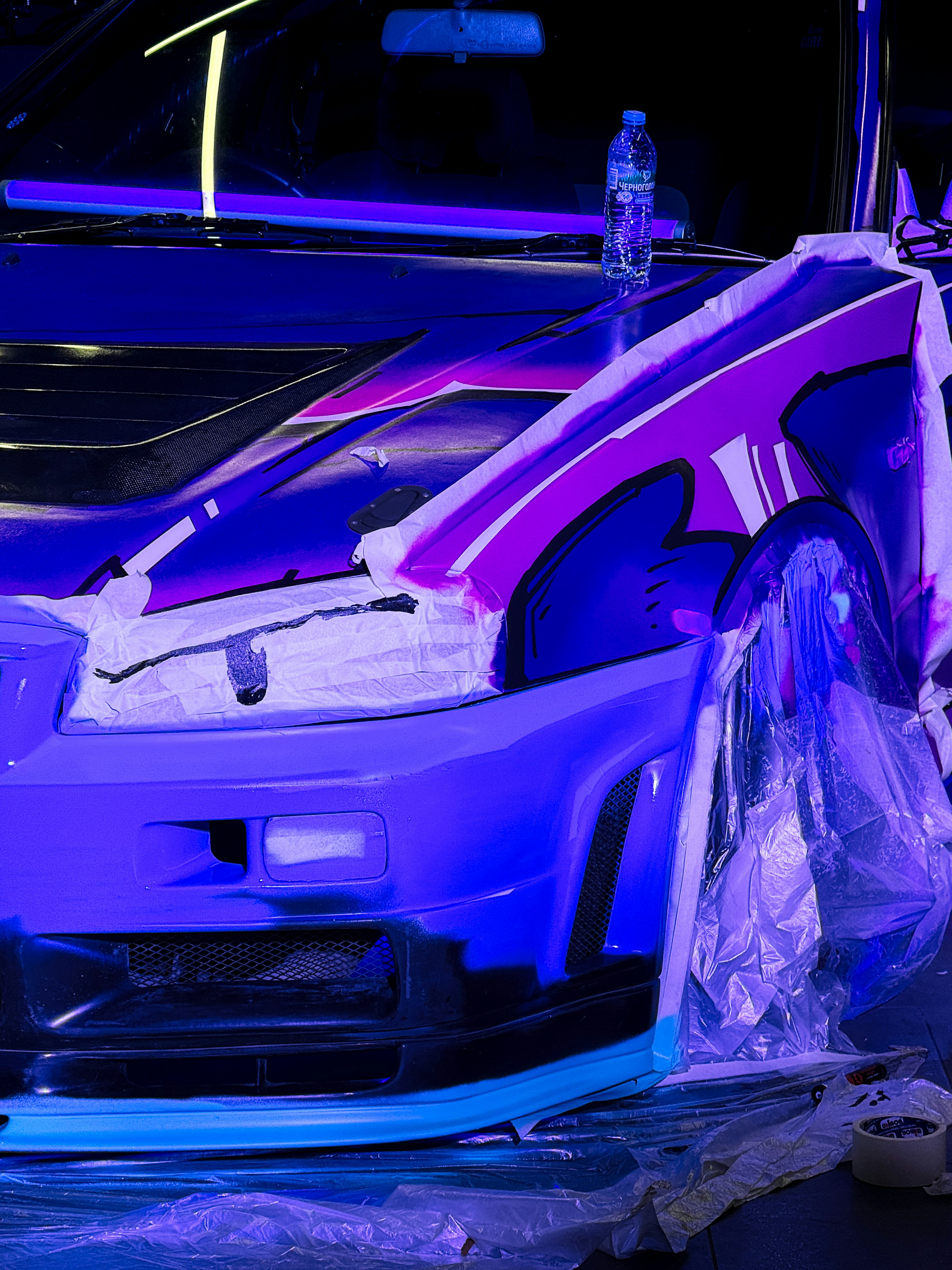 Neon Mirage: Neon-lit Drift Car Undergoing Repair