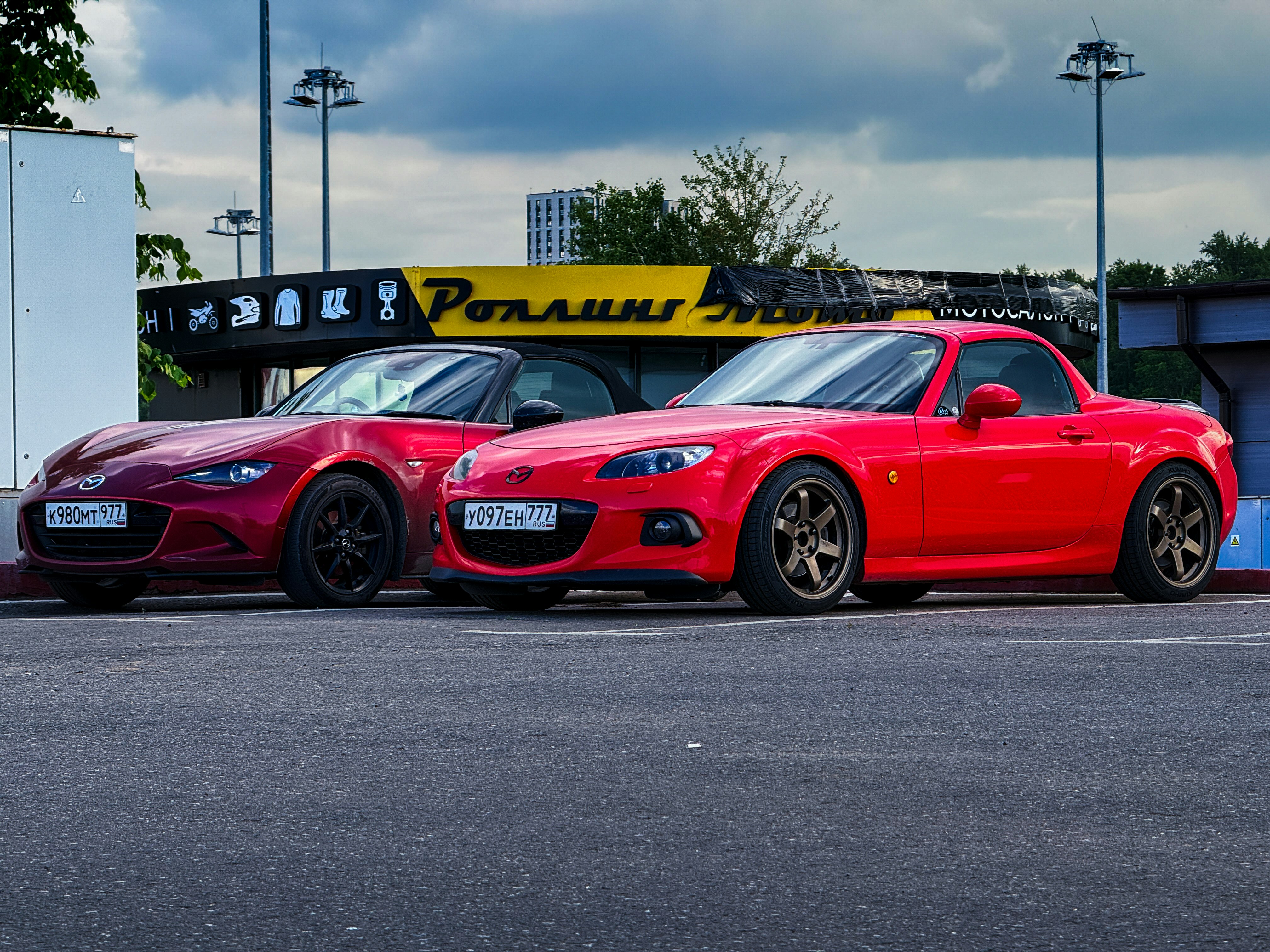 Red Duo: Pair of Sports Cars in a Parking Lot