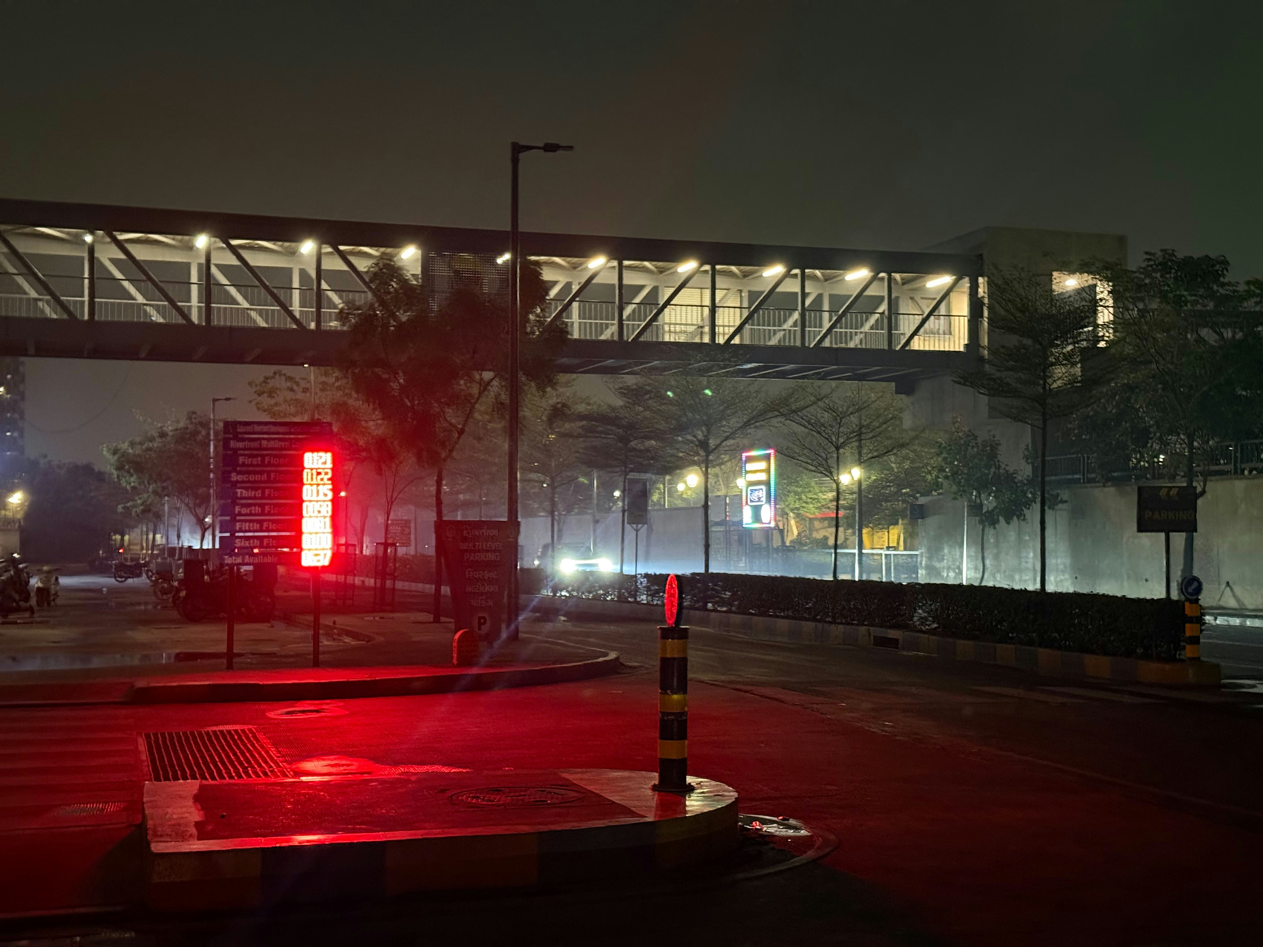 Red Neon Crossroads Under a Pedestrian Skywalk