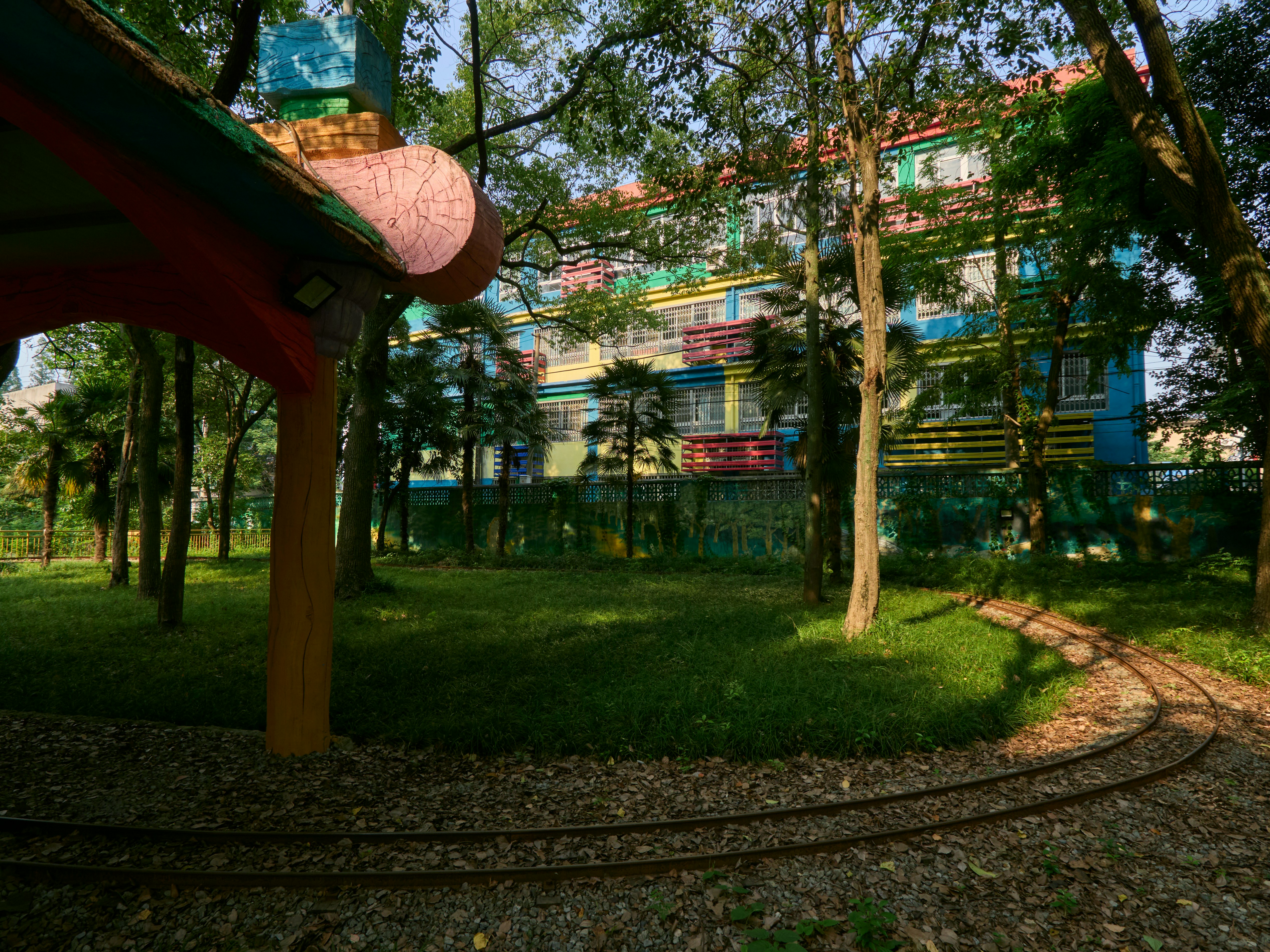 Playground Edges and Colored Building in Dappled Park Light