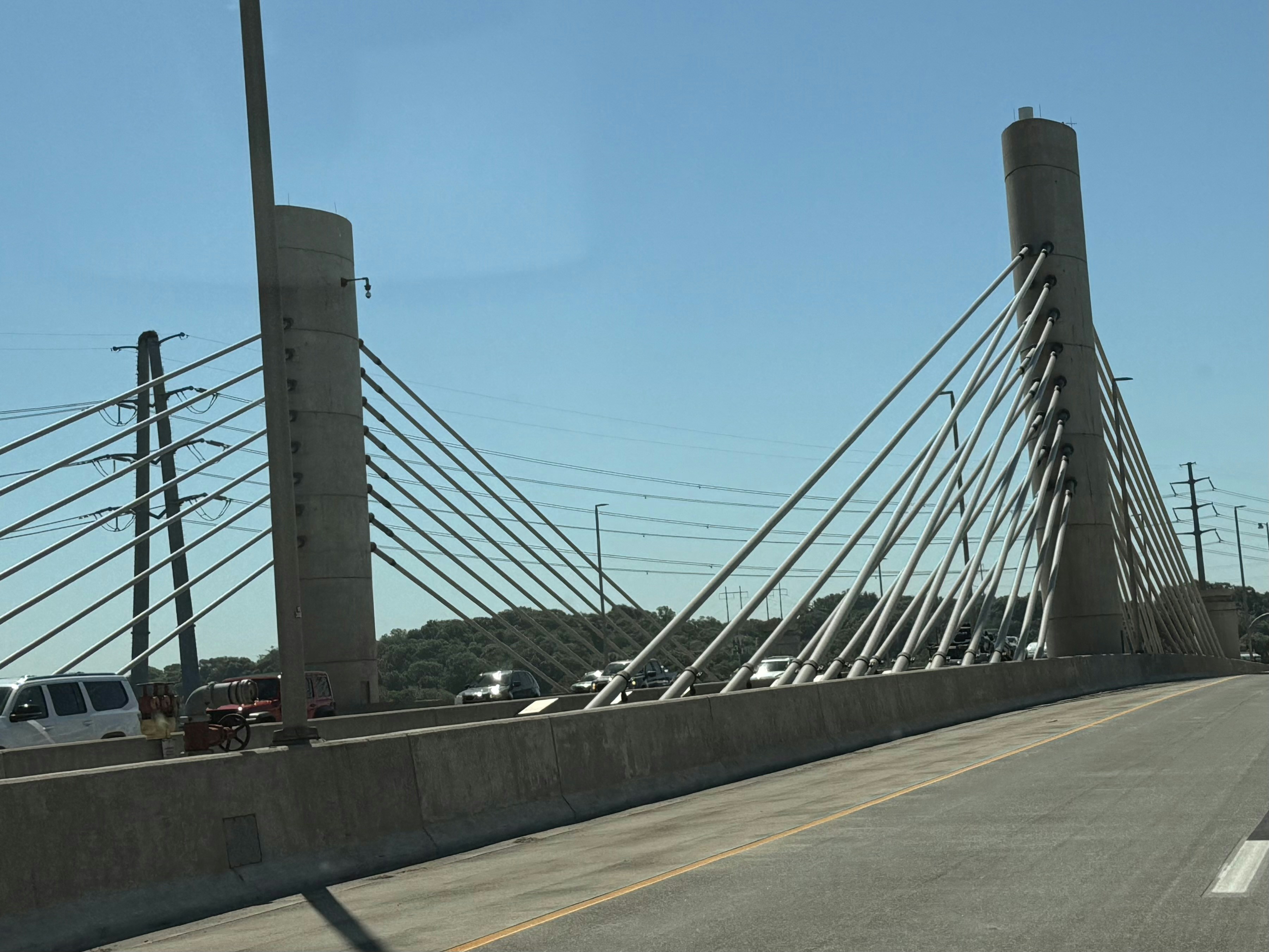 Cables and Concrete: A Modern Bridge Arches Across the Road