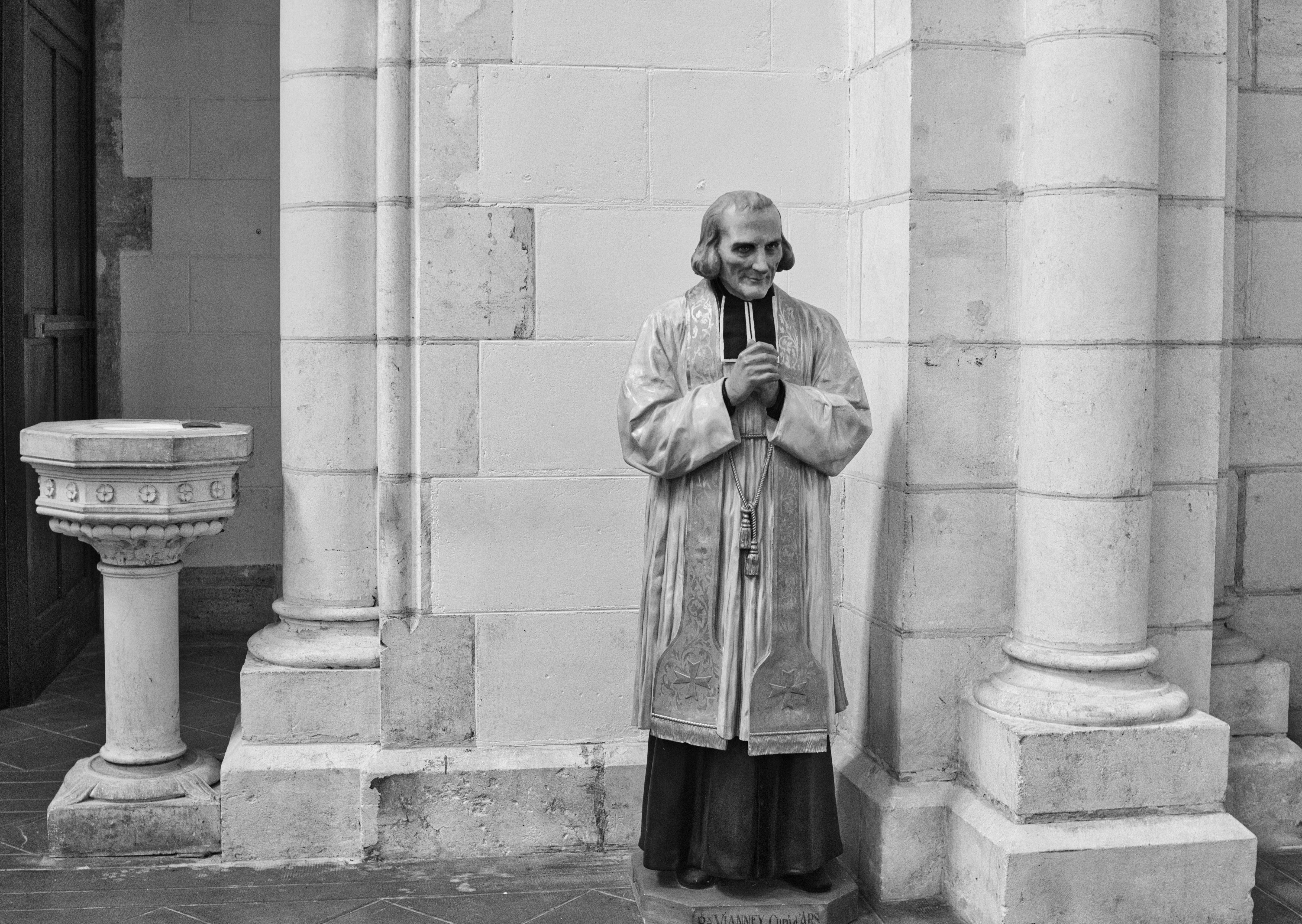 The Cleric at the Doorway: A Quiet Portrait in Stone