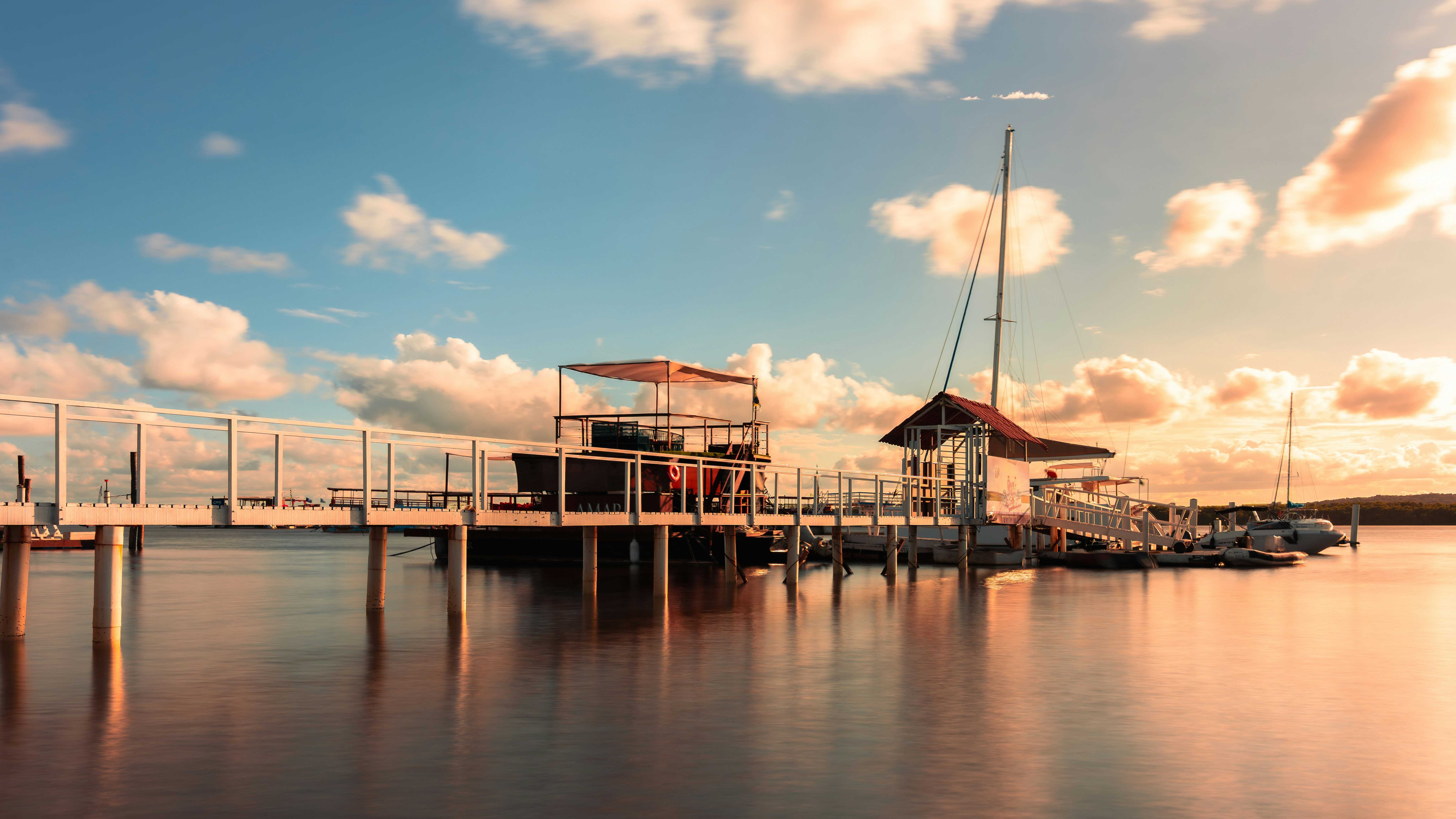 Sunlit Pier at Dusk: A Tranquil Waterfront Ensemble