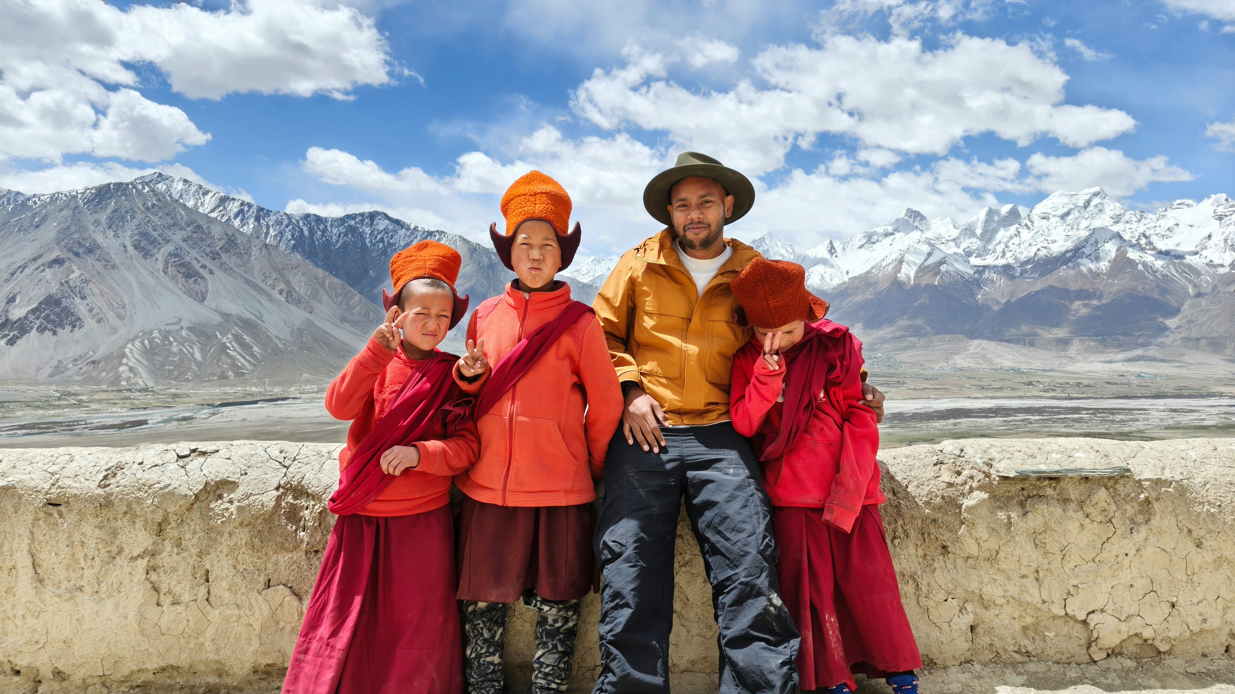 Family Portrait Against Snowy Peaks and Desert Rim