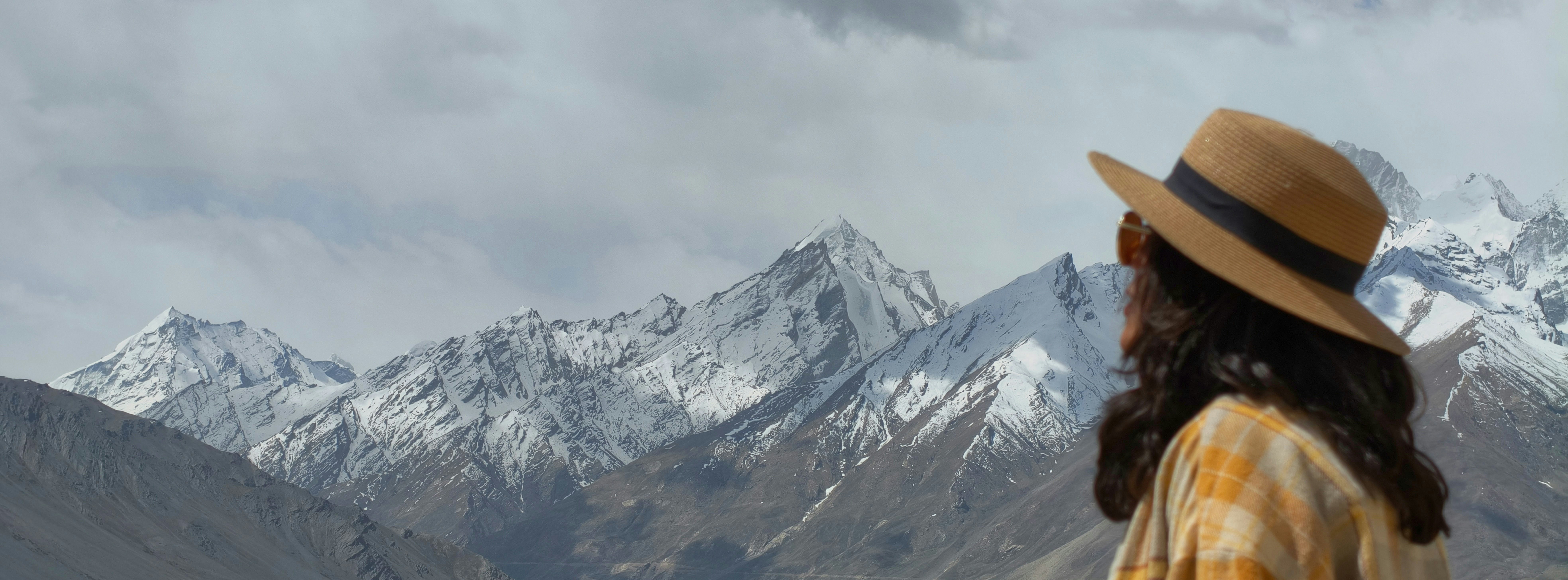 Windward Gaze: A Traveler with Snow-Tailed Peaks