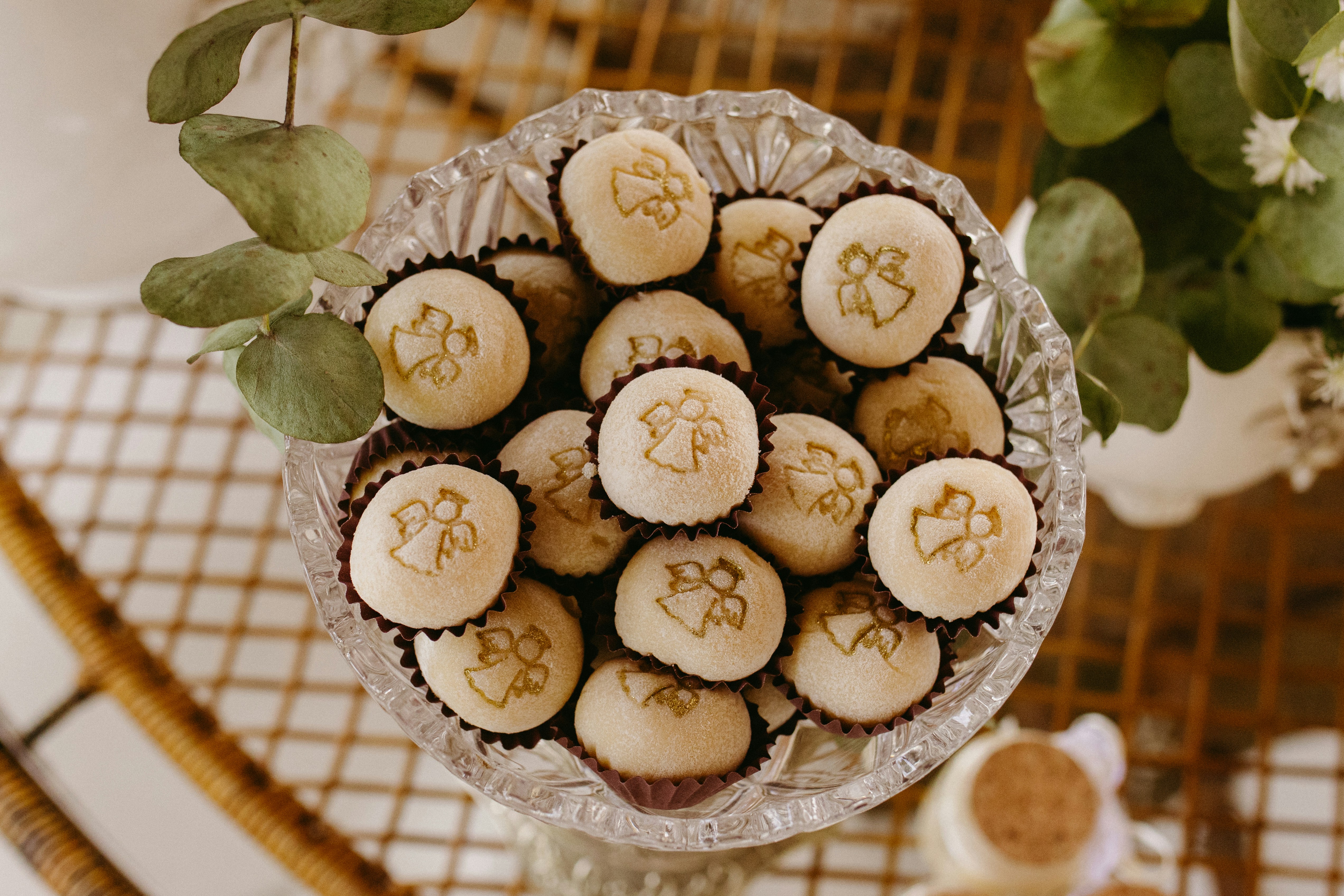 Candy-tinted centerpiece: a tray of delicate vanilla cookies crowned with cocoa accents