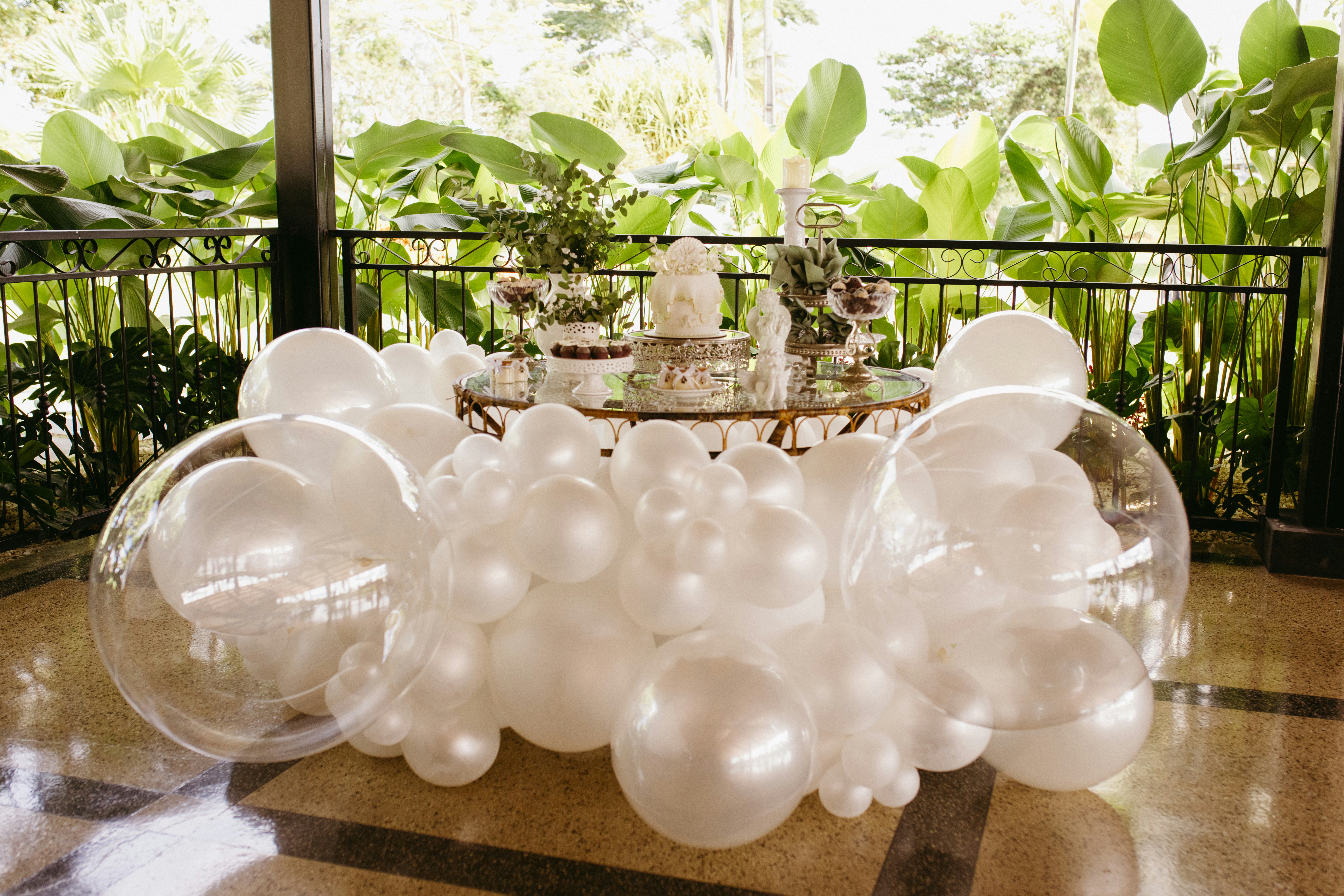 Bubble-laden celebration centerpiece under tropical glass