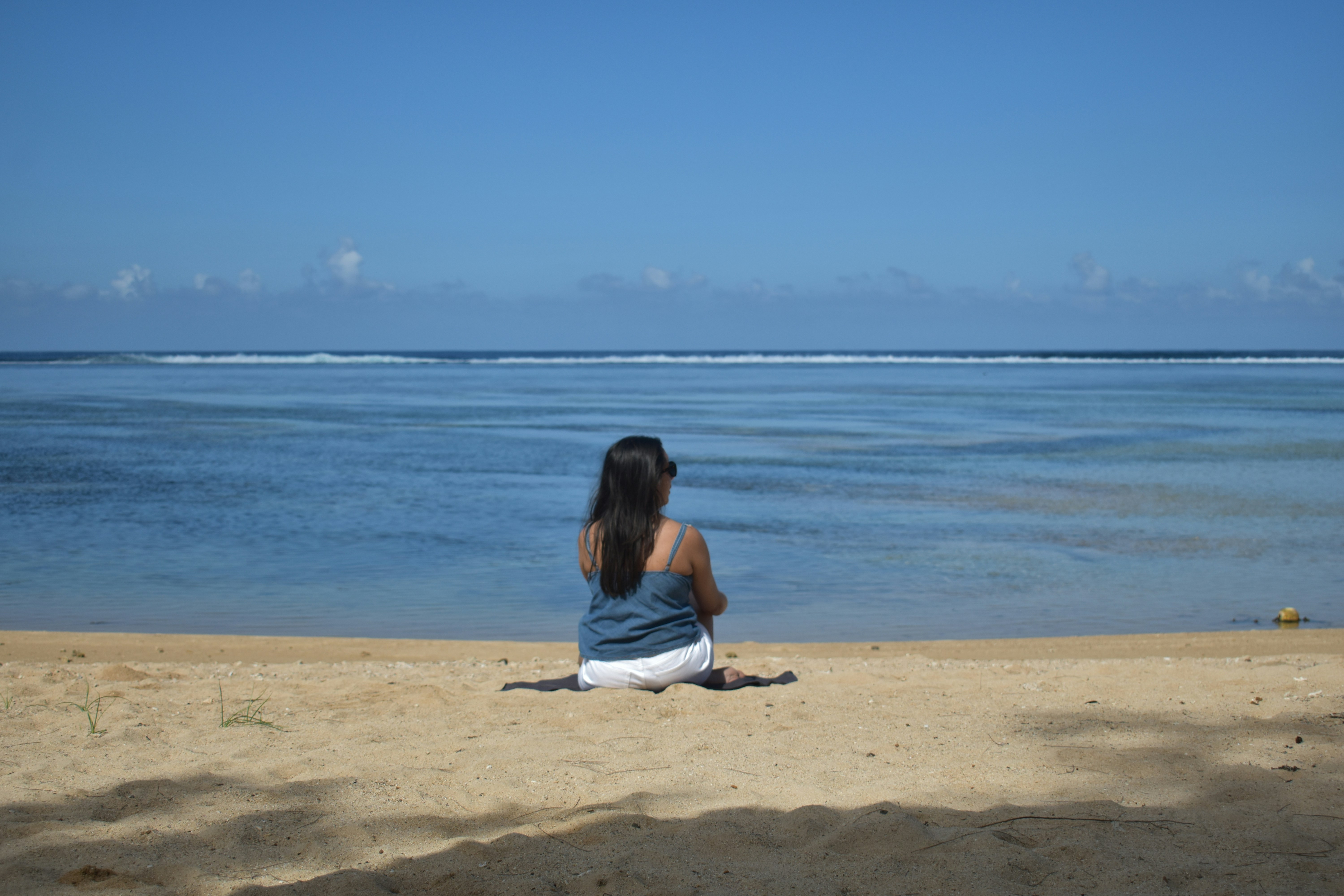 Seated by Sea: Quiet Moment of a Beach Wanderer