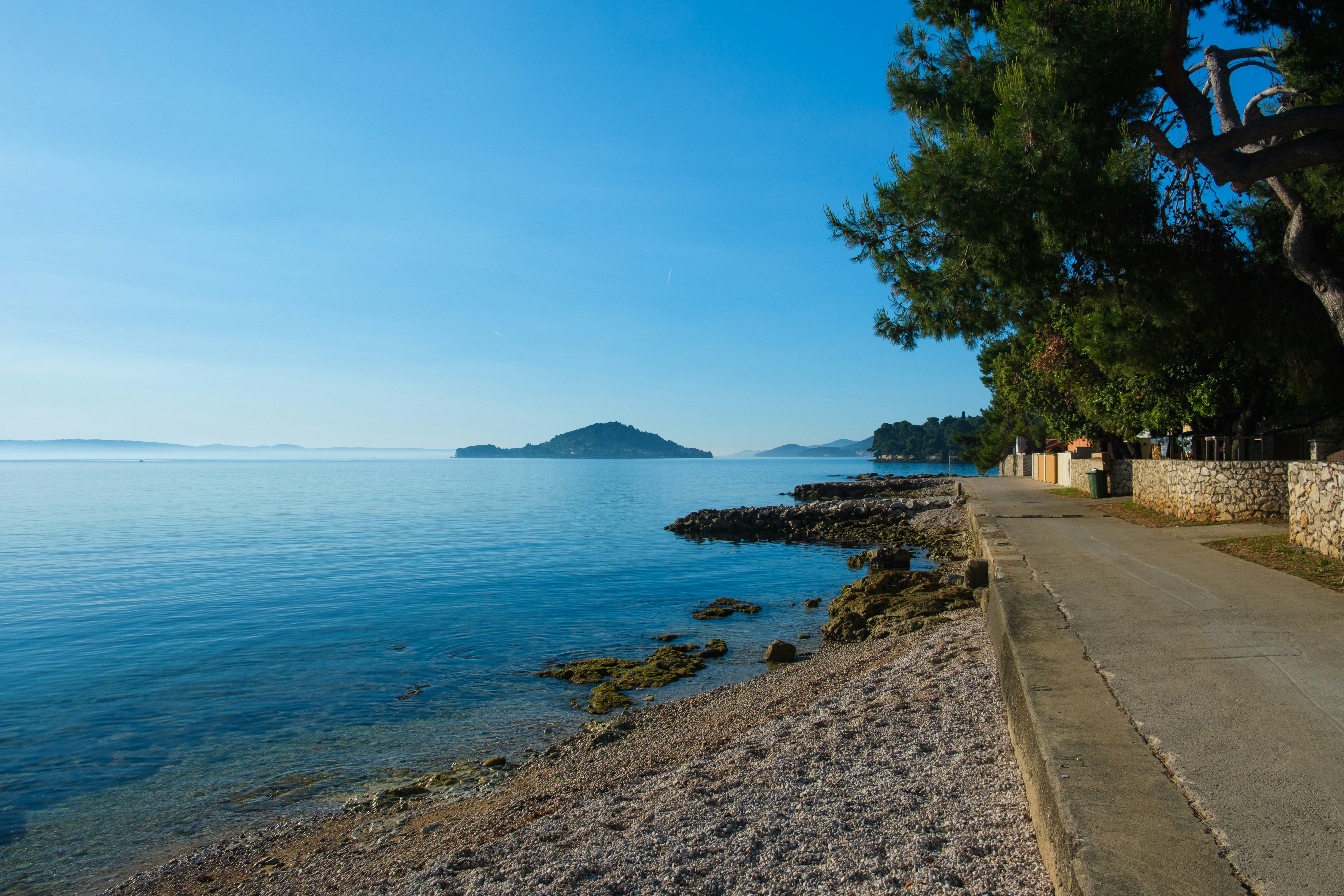 Lined Promenade by Calm Sea: Coastal Path, Rocks and Waterfront Palette