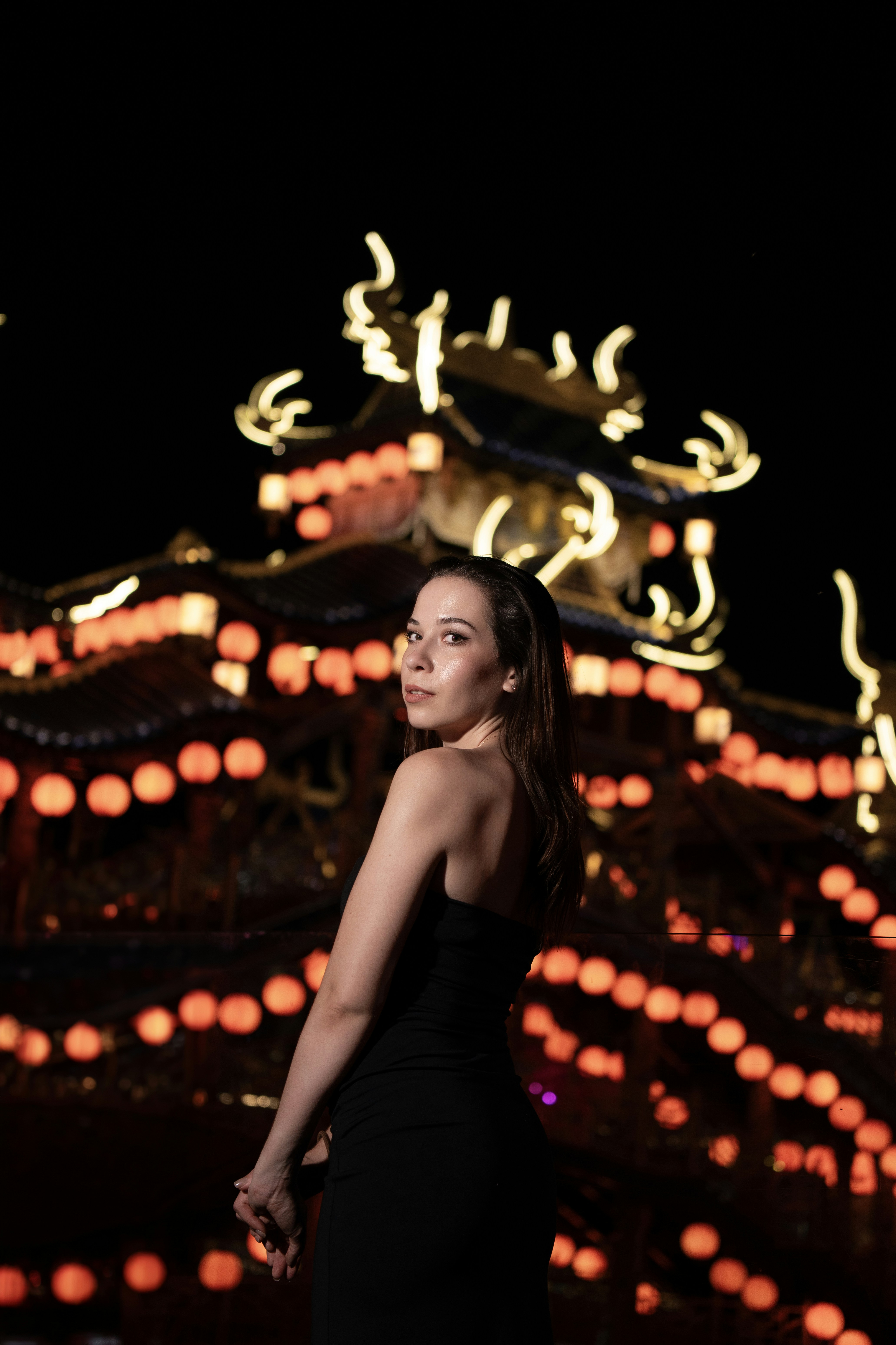 Midnight Glow: Portrait Beneath Lanterns of a Templescape