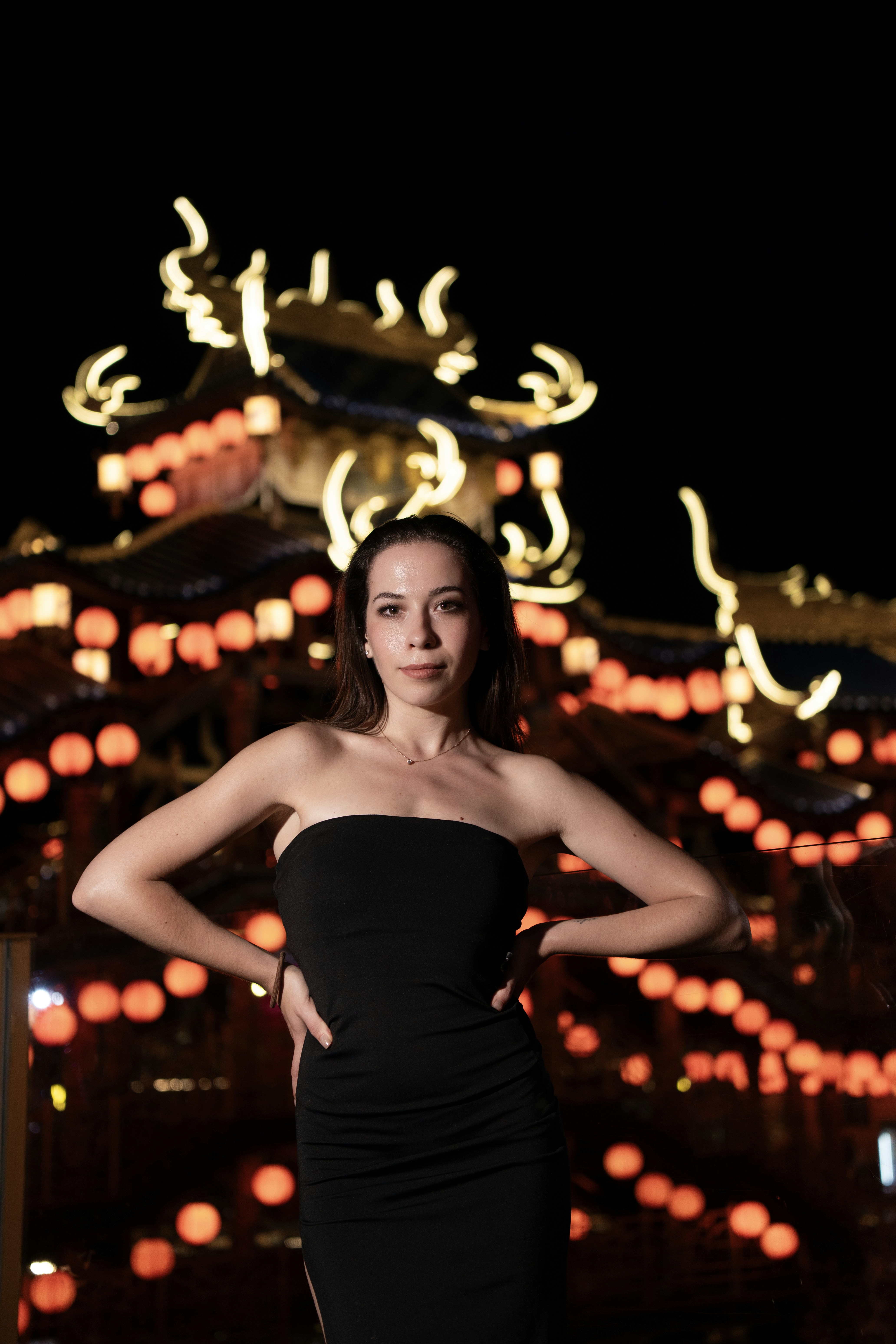 Glow Behind the Velvet: A Confident Pose Under Lantern Light
