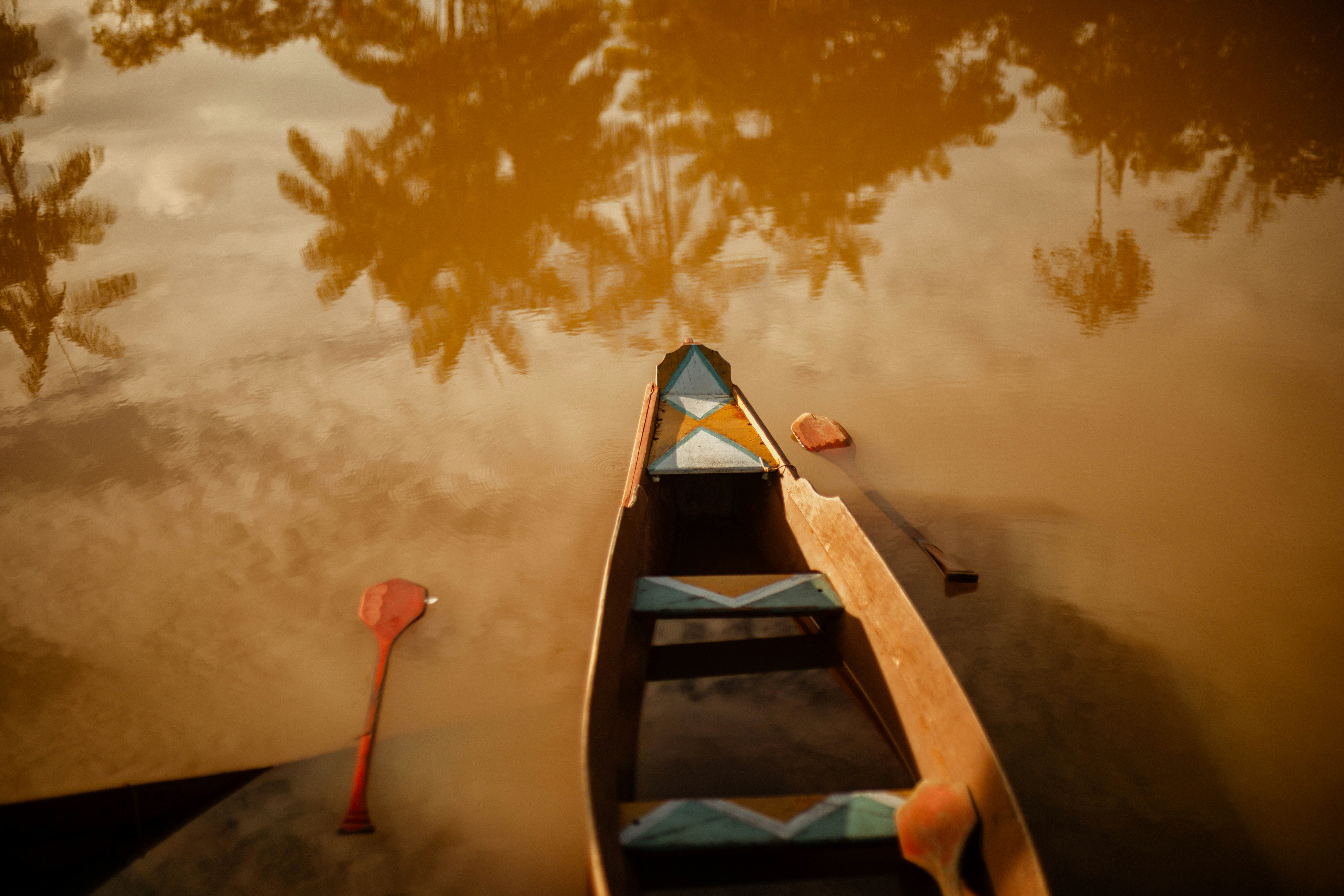 Echoes of the Oar: A Canoe Quietly Drifts on Quiet Water