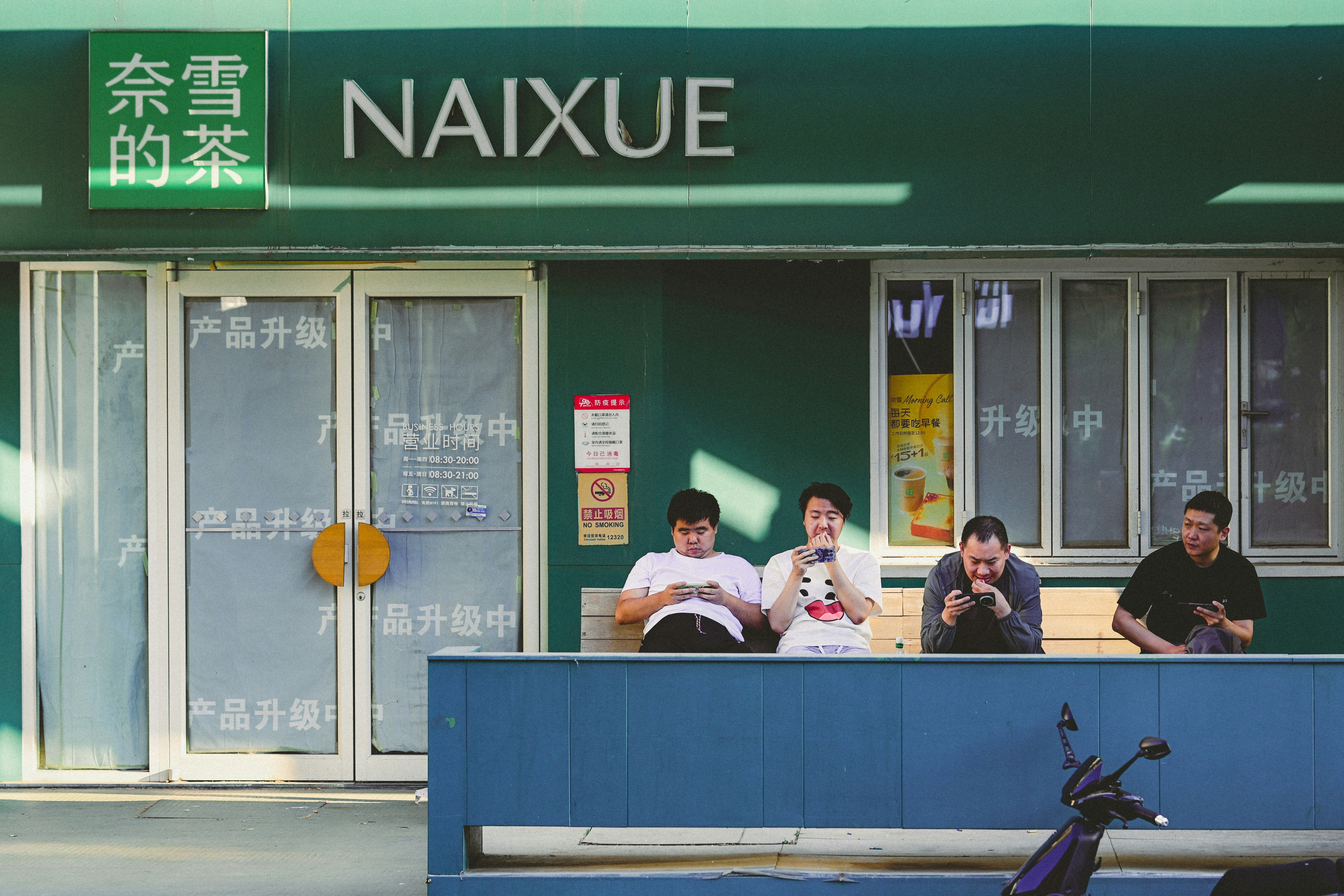 Midday Pause on a Neon Green Facade