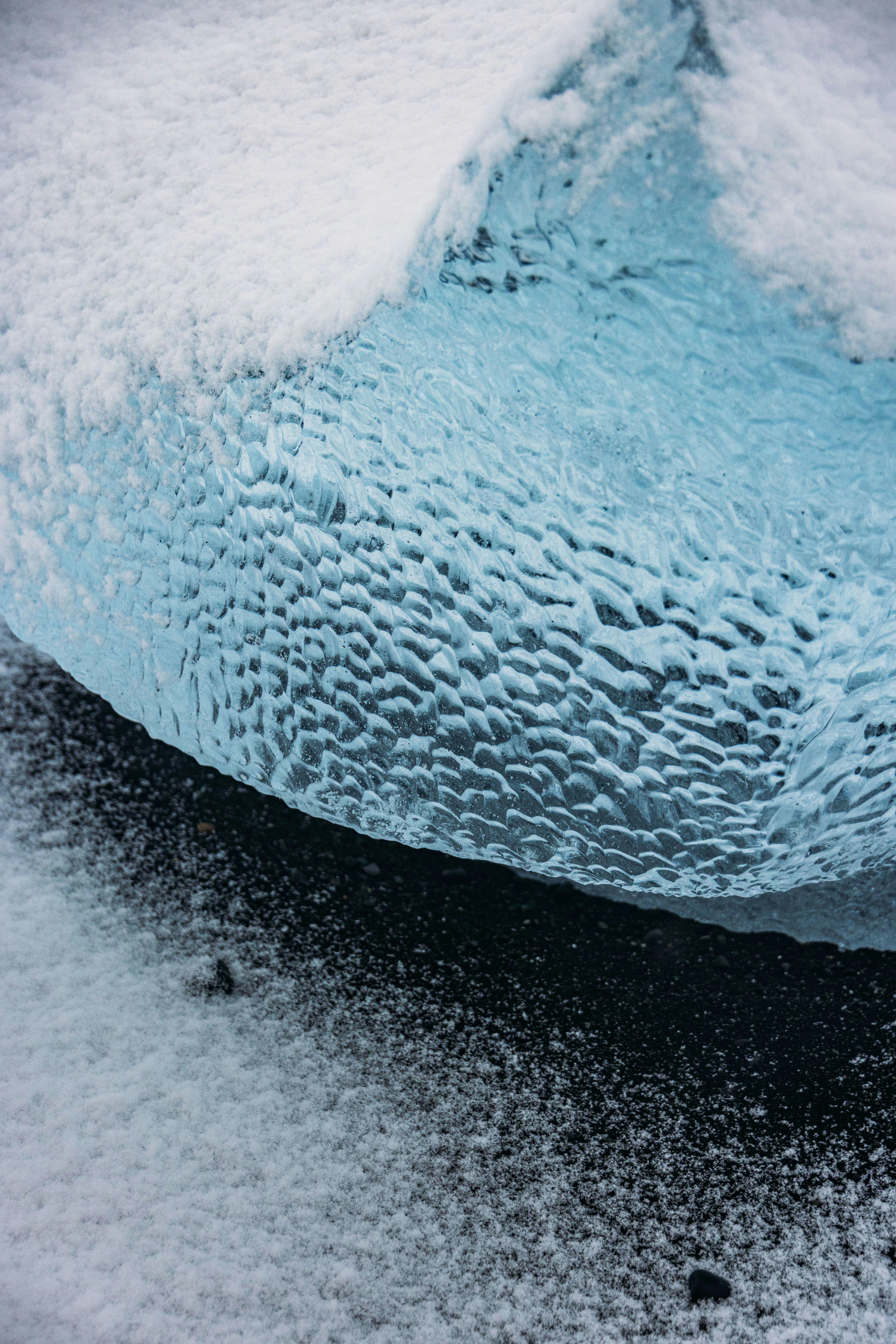 Faceted Glacier: A Close-Up of Icy Texture and Blue Light