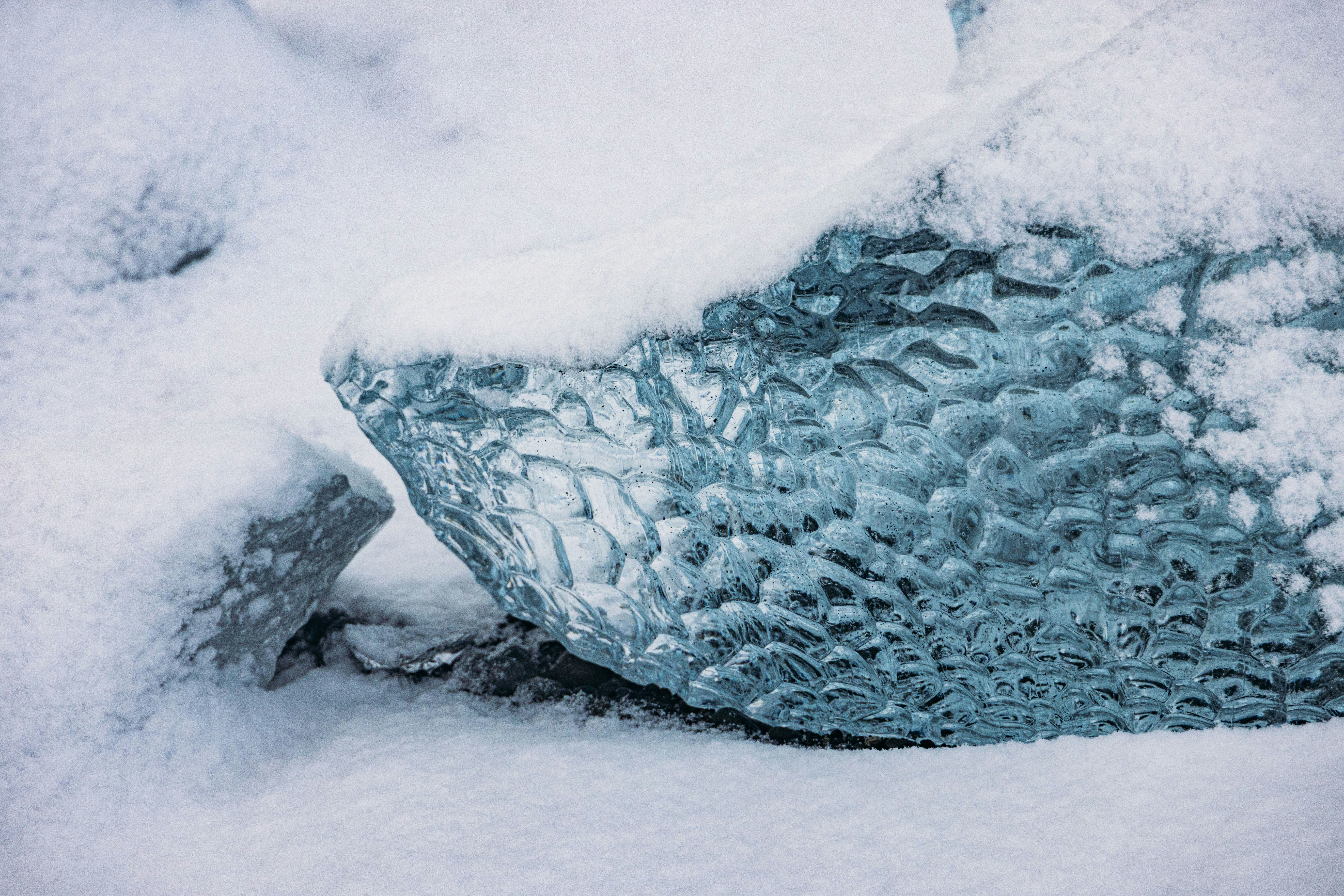 Iced Facets: Snow-Cloaked Glacier Edge in Soft Light