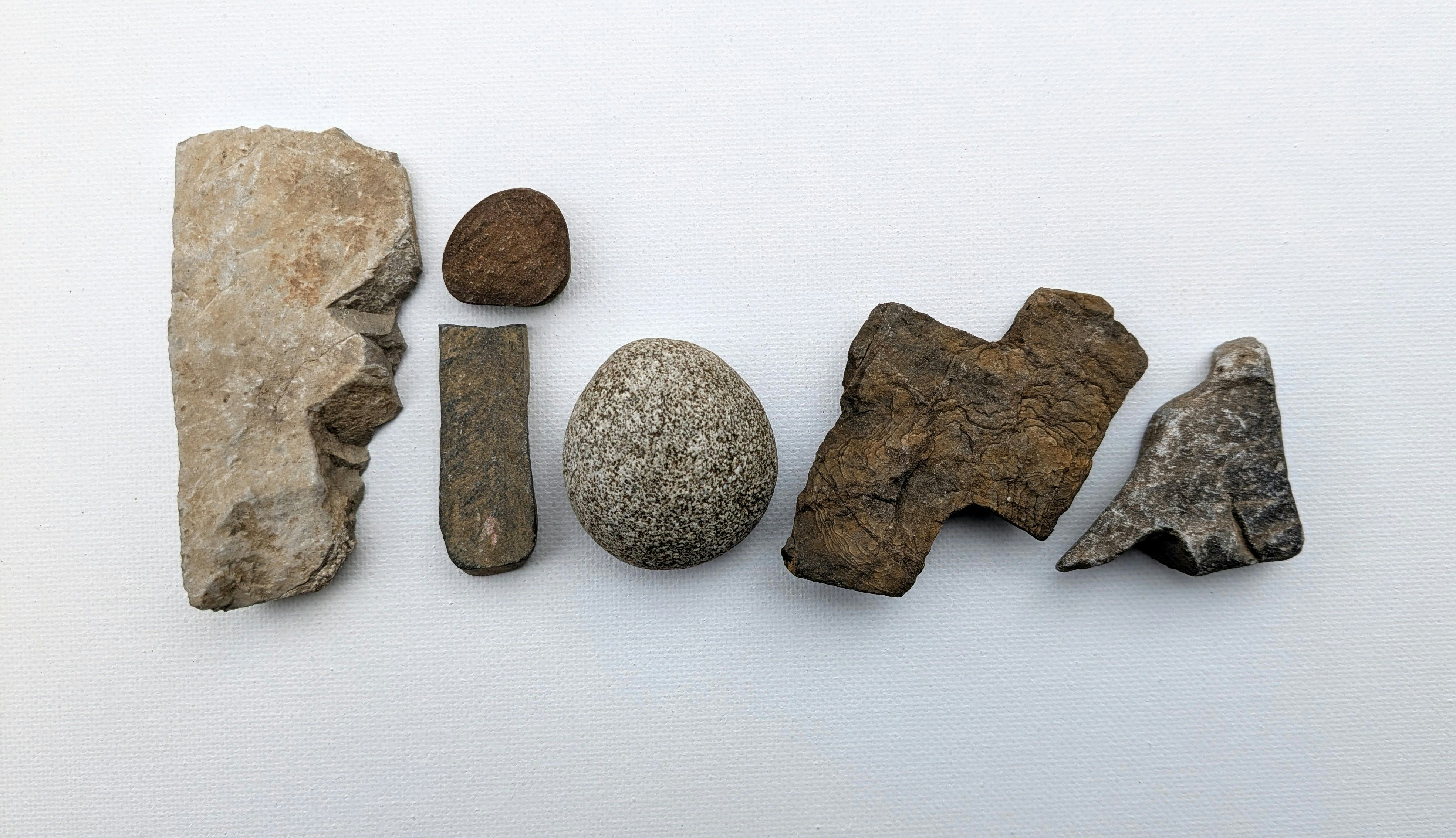 An arrangement of naturally fractured stones (found in Kananaskis, Alberta) spelling out a name.