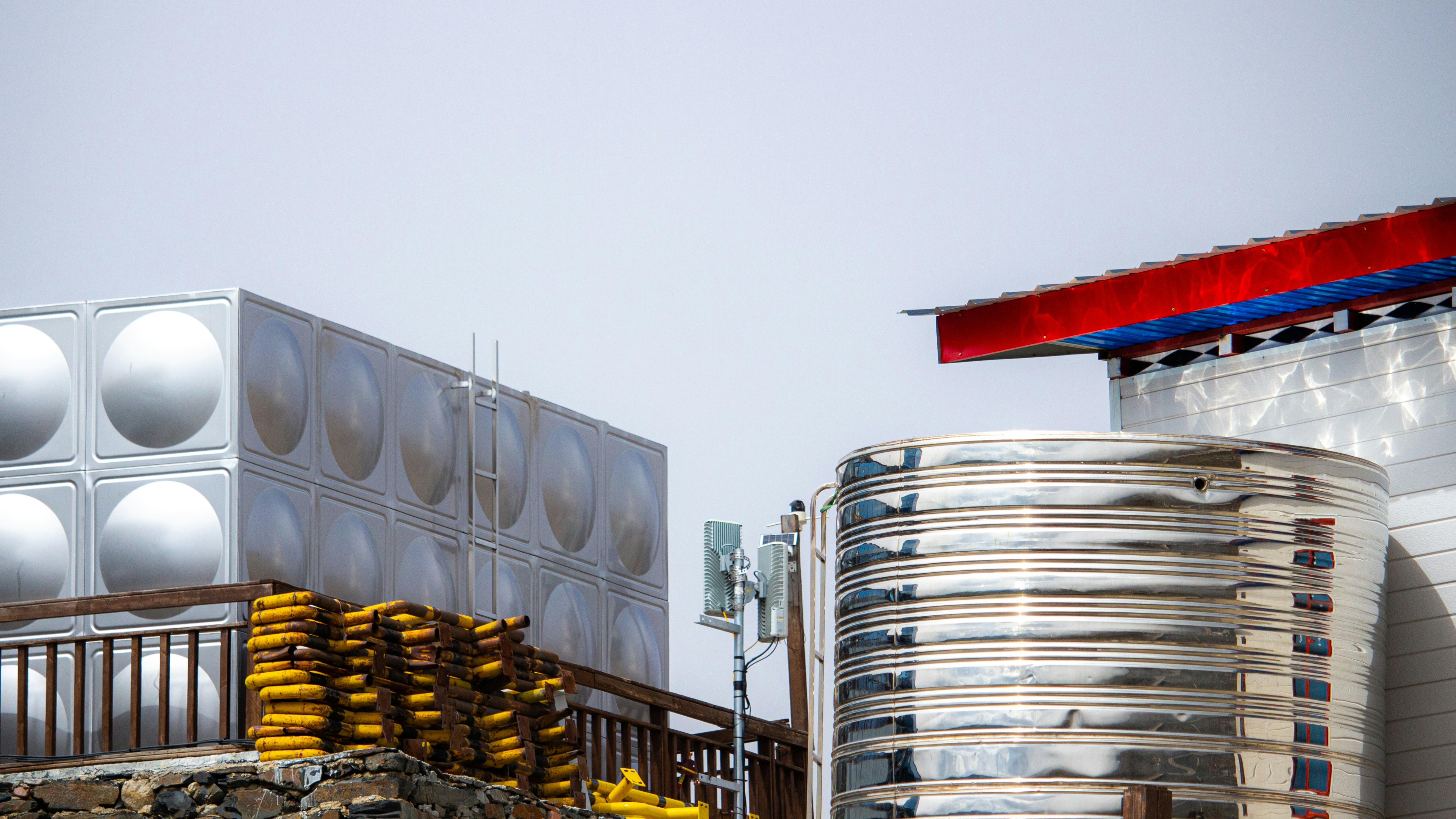 Industrial Silhouettes: Metal Silos and Water Tanks at Dusk