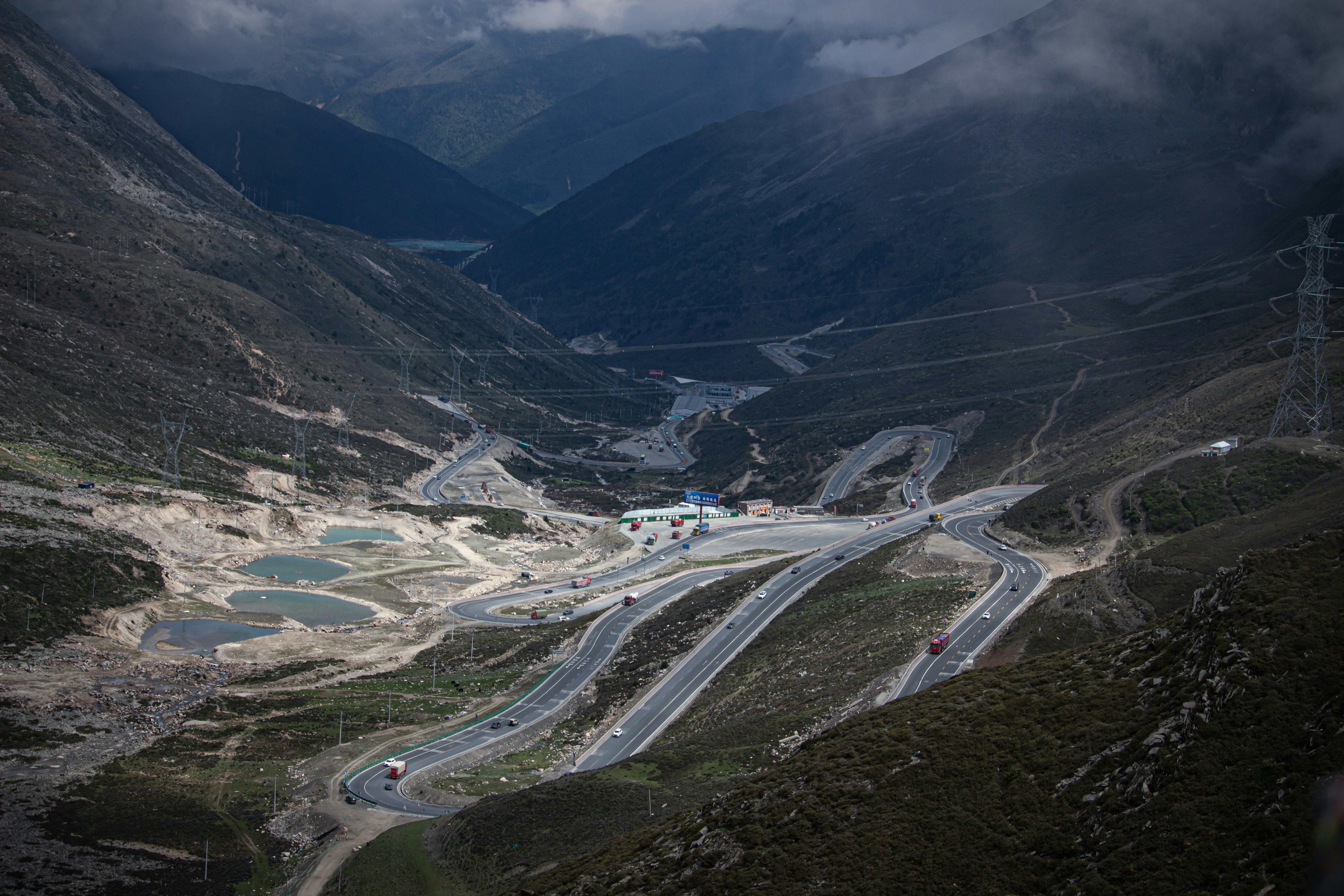 Serpentine Summit: Aerial Confluence of Winding Roads Through Alpine Pass