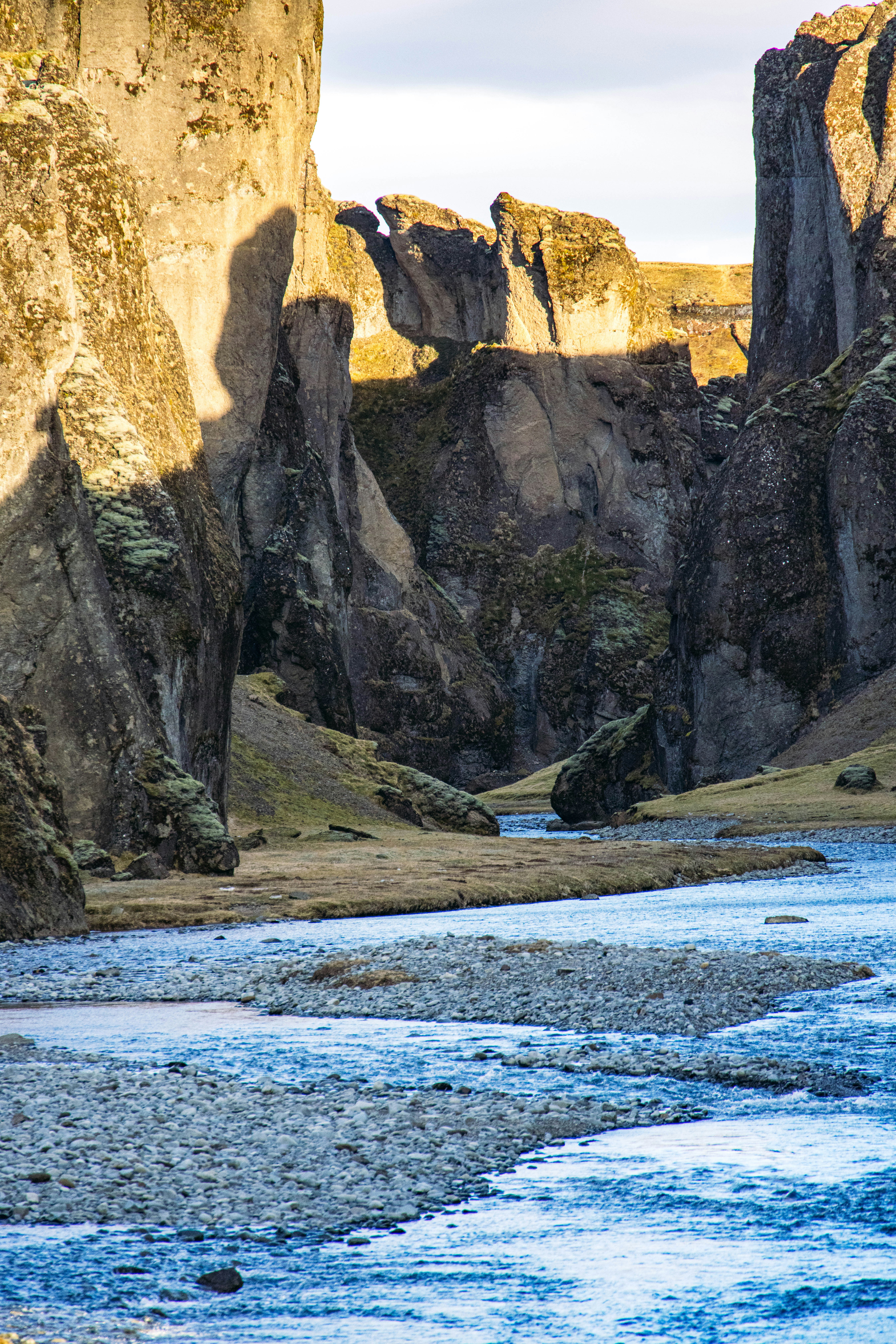 Shadowed Gorge: A River Winding Between Monolithic cliffs