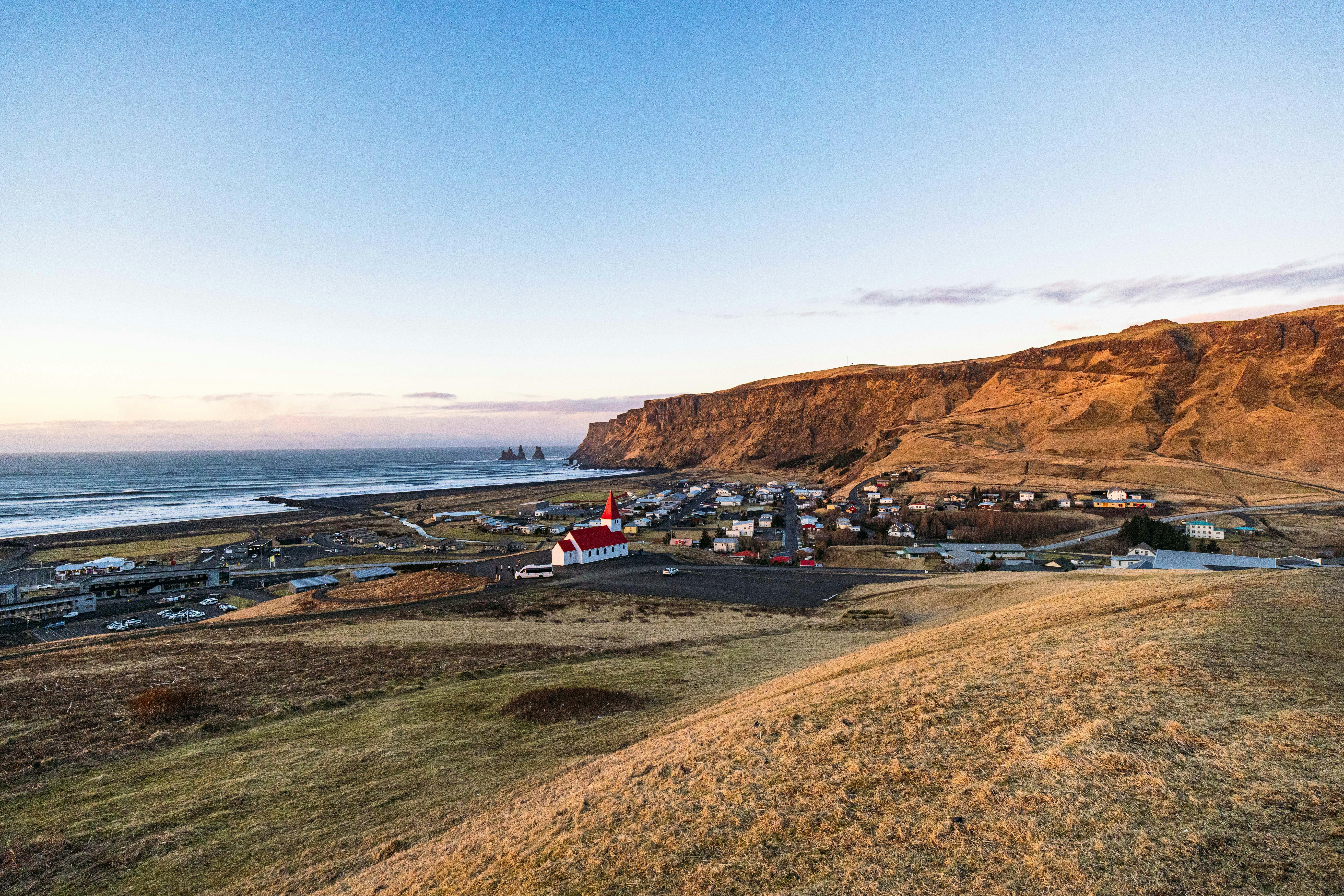 Coastal Village Nestled at the Base of Weathered Cliffs