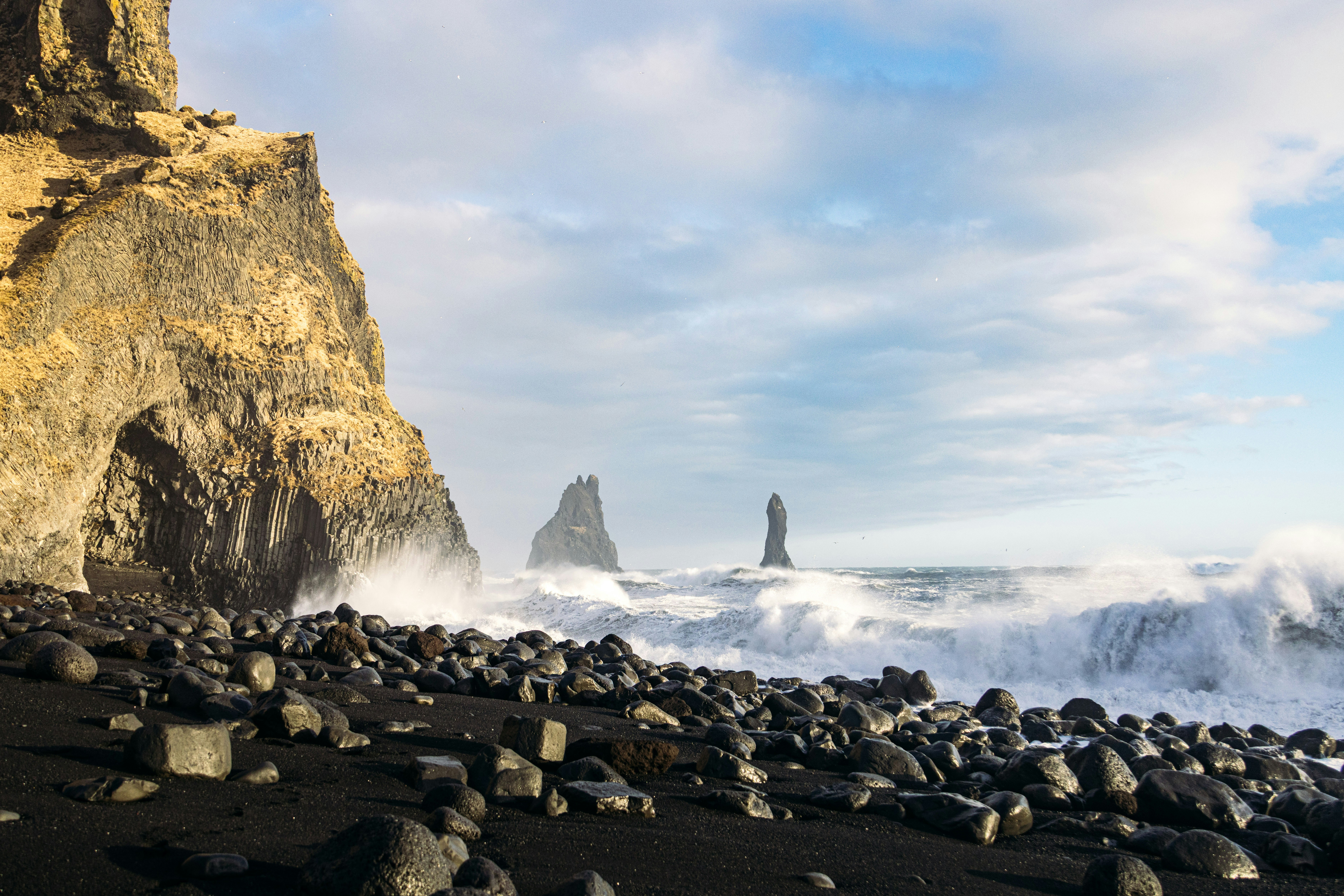 Sea spray and basalt sentinels along a cliffed shoreline