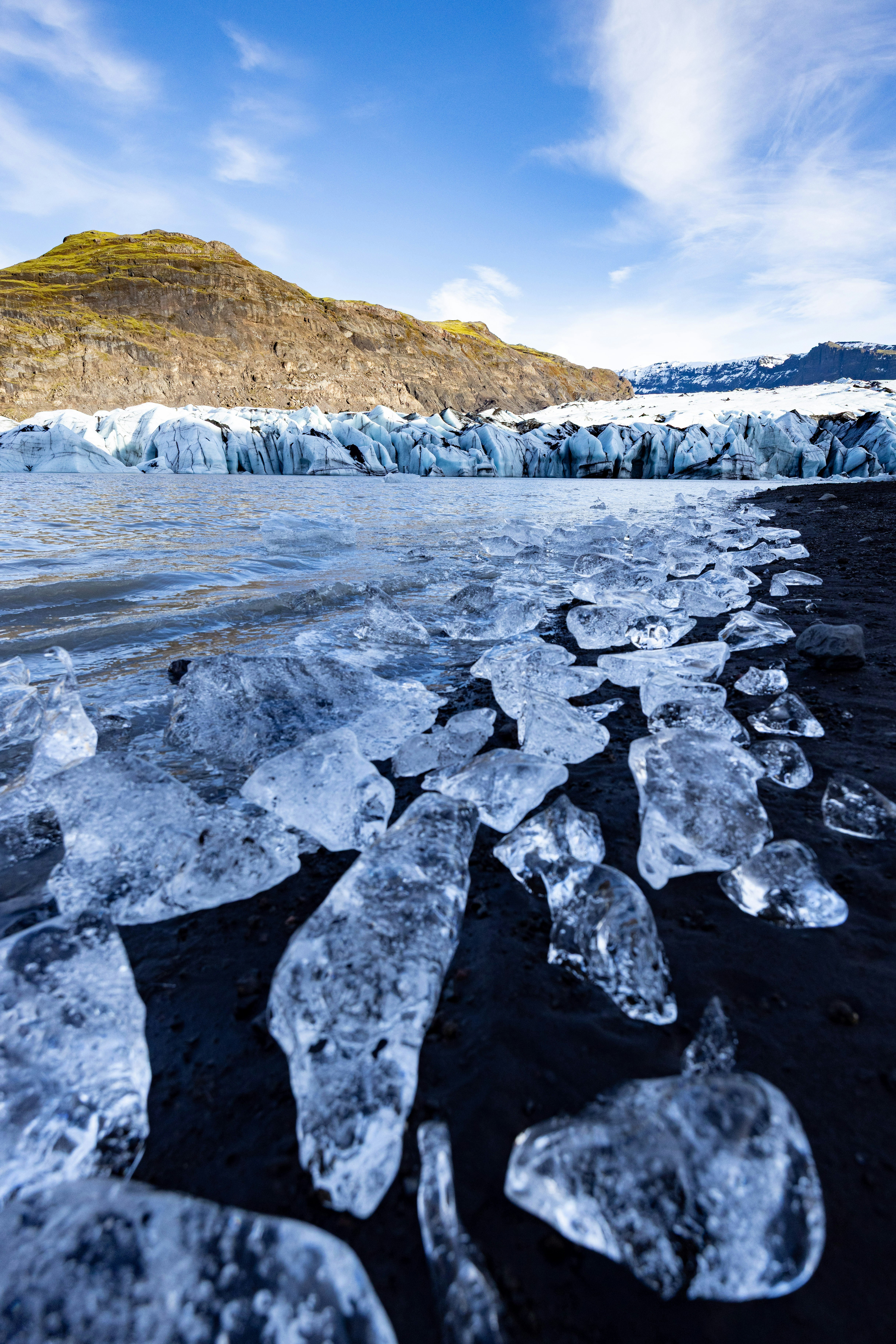 Glacial Pathways: Ice Fragments Leading Toward a Rugged Glacier Crown