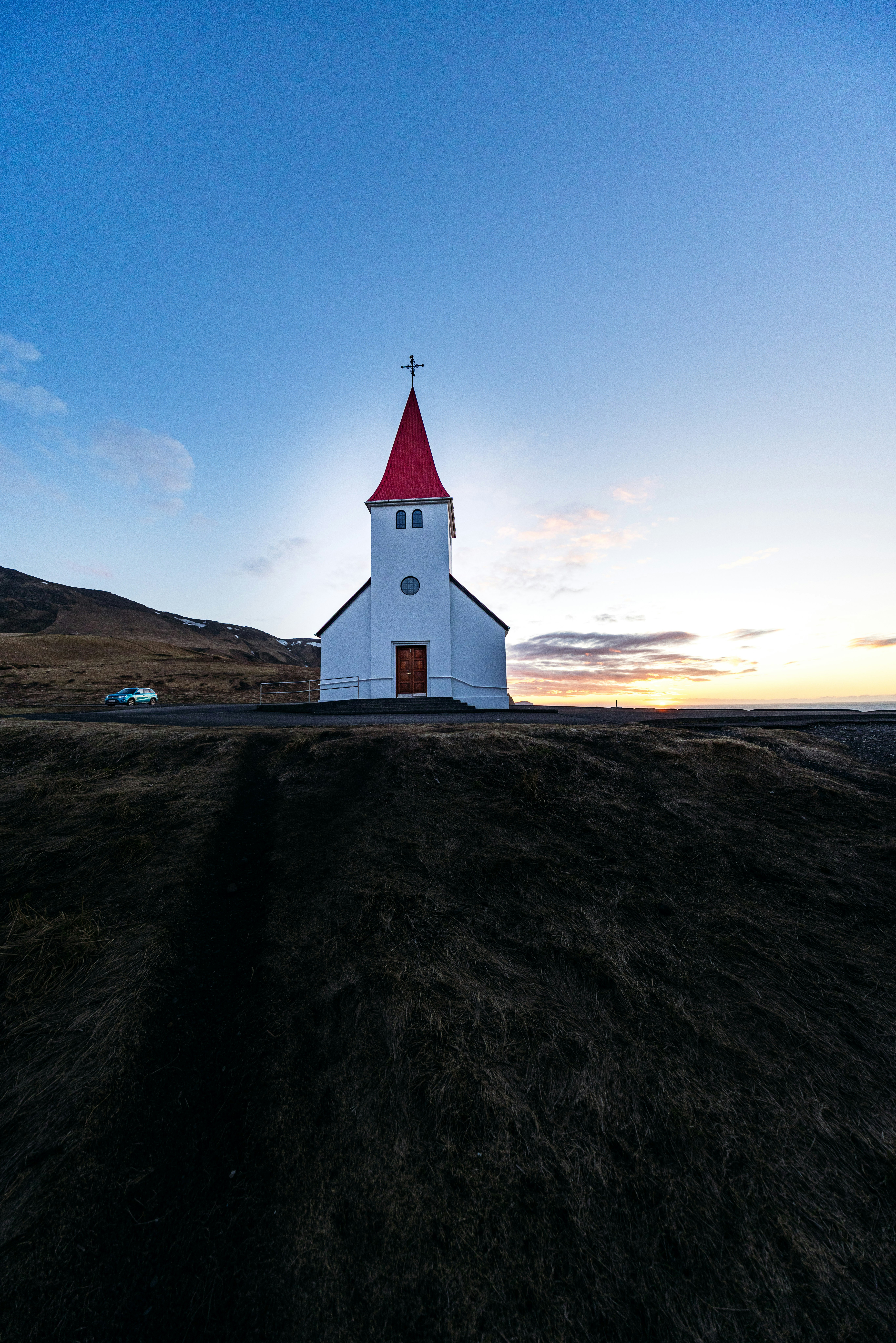 White Chapel on the Horizon: A lone church under a calm Icelandic sky