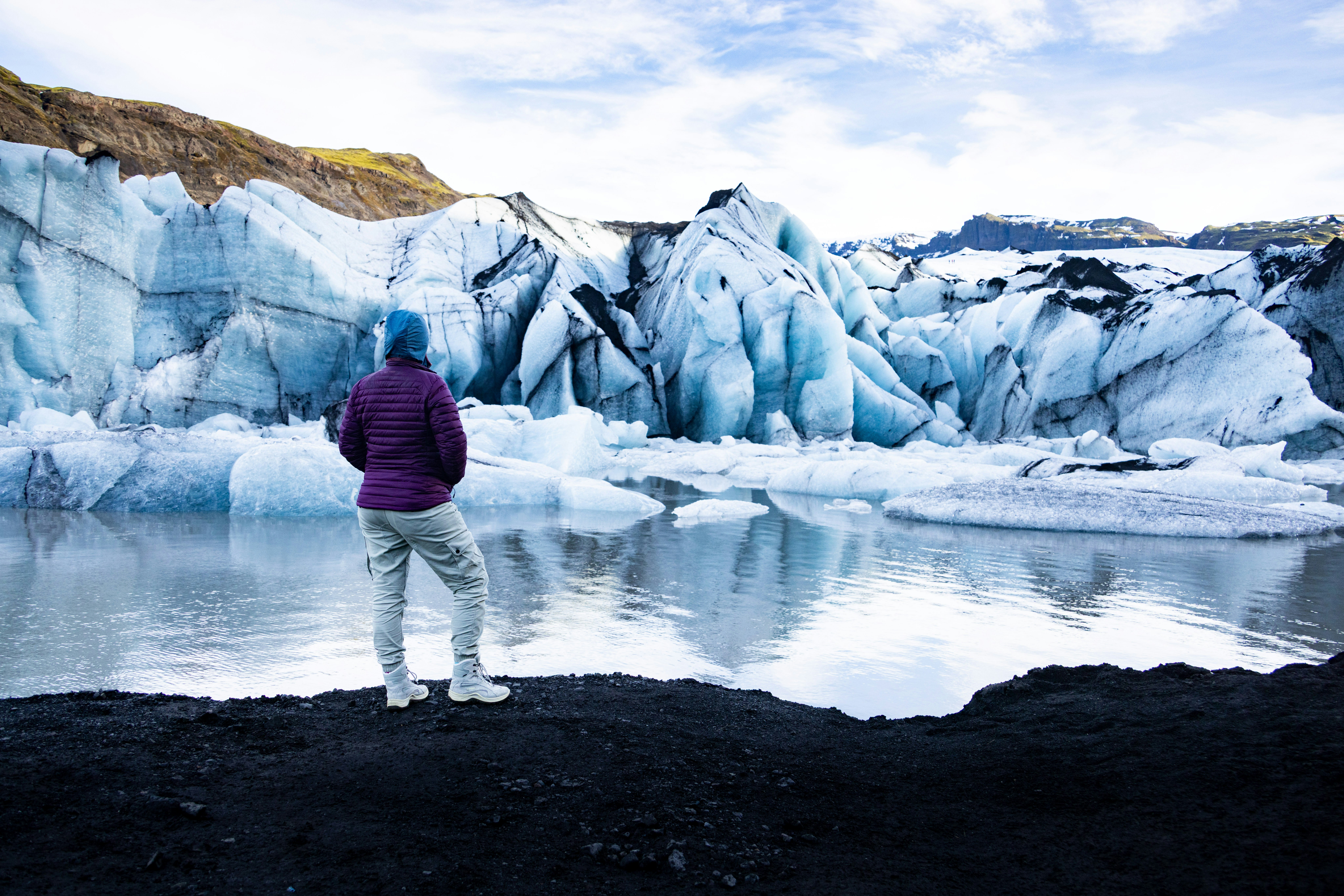 Icebound Traveler Behind a Rift of Blue