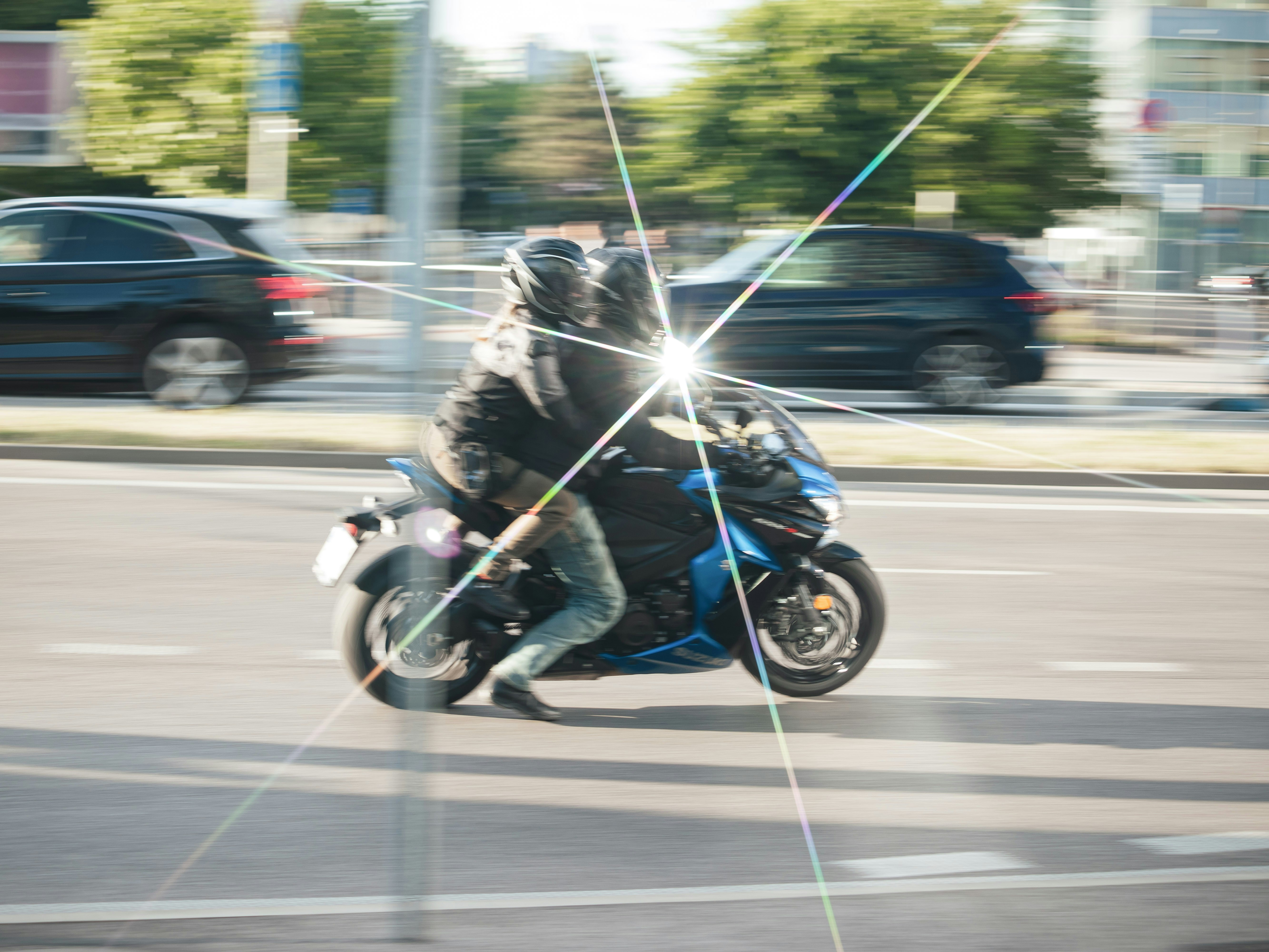 Chrome on the Move: A Blurred Street Ride with a Bright Burst