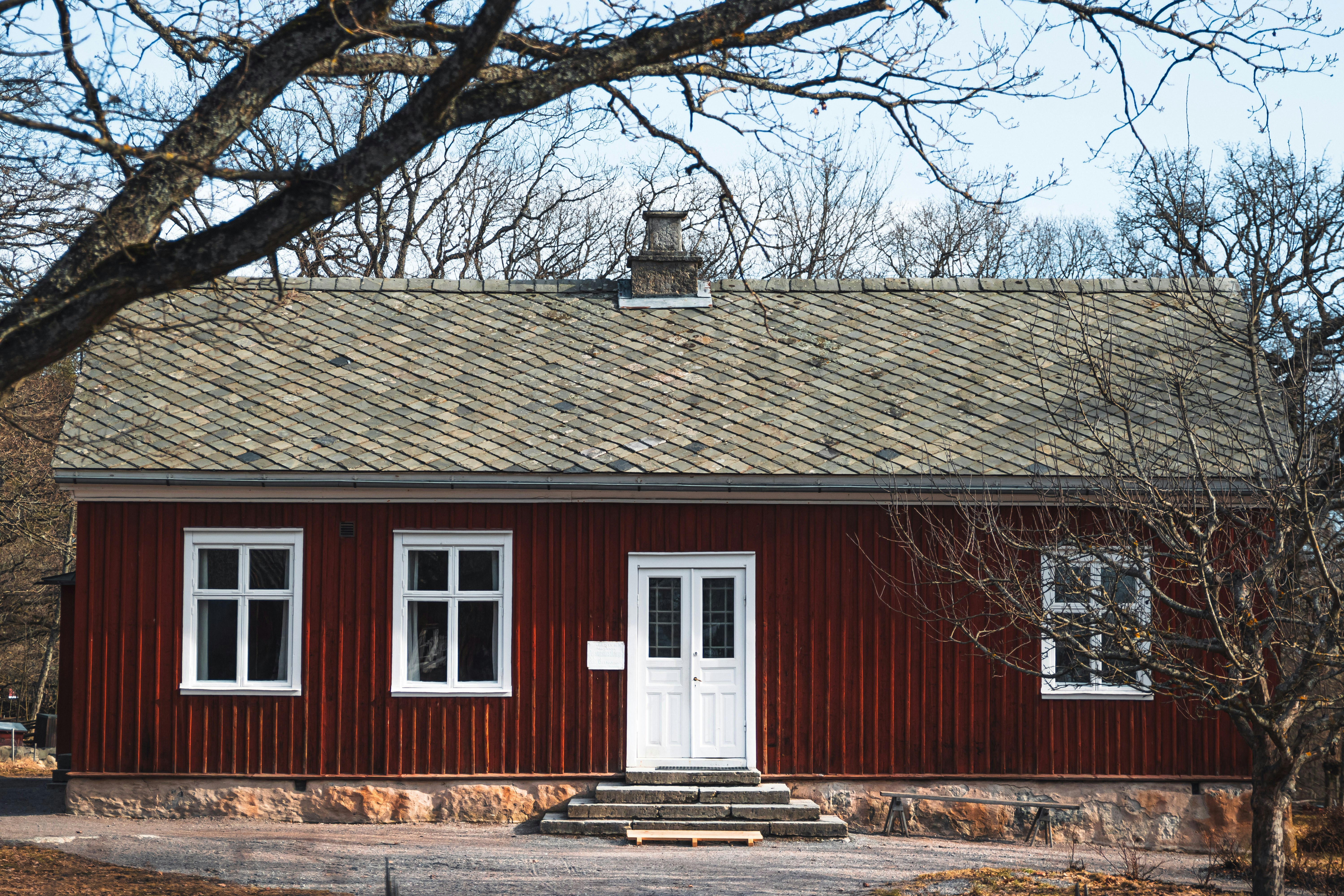 Red Cabin on Quiet Street: Symmetry, Wood Siding, and Winter Light