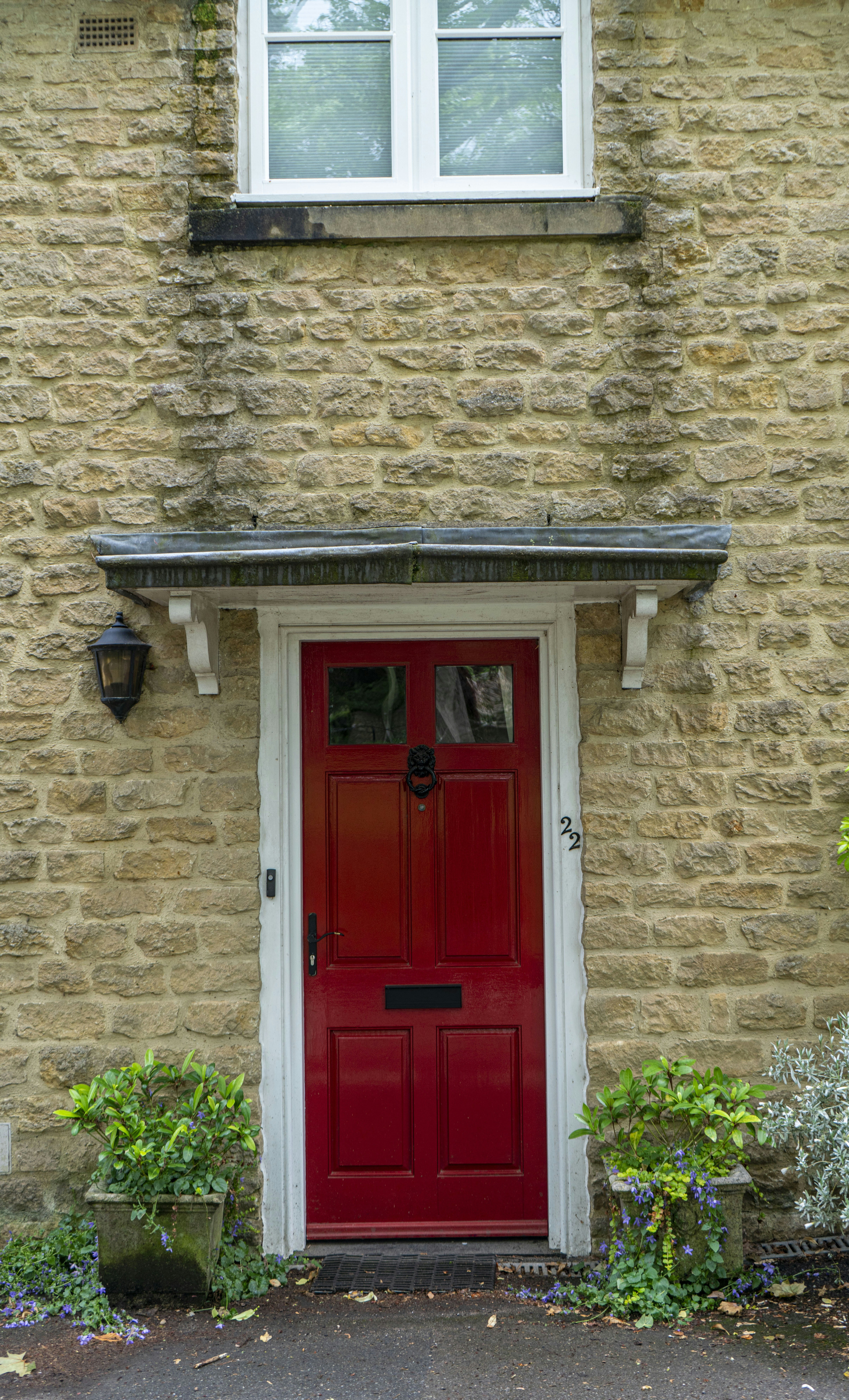 Crimson Doorway: A Charming Stone Home Front