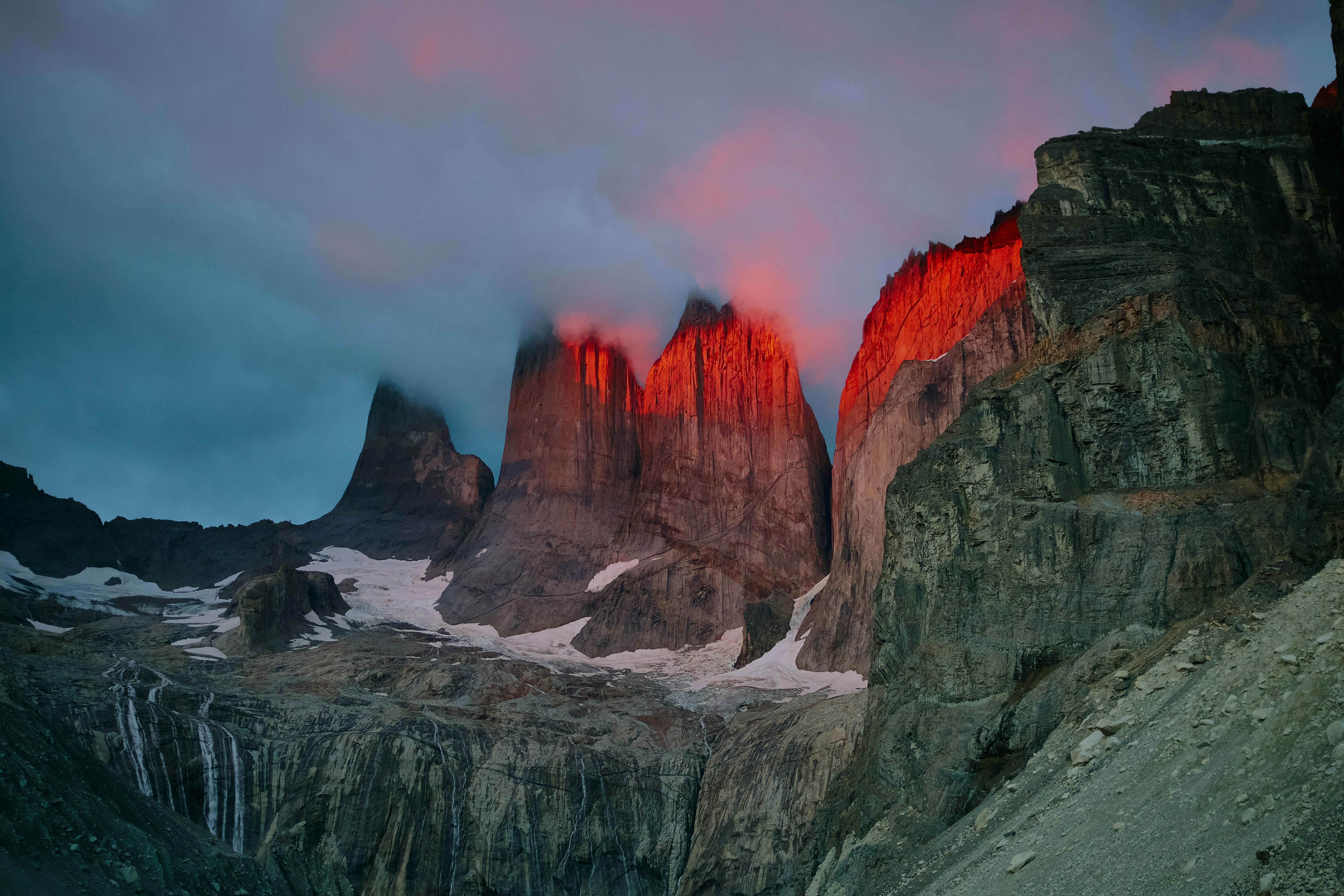 Crimson Summit: Sunrise Cliffs Piercing the Clouded Peak
