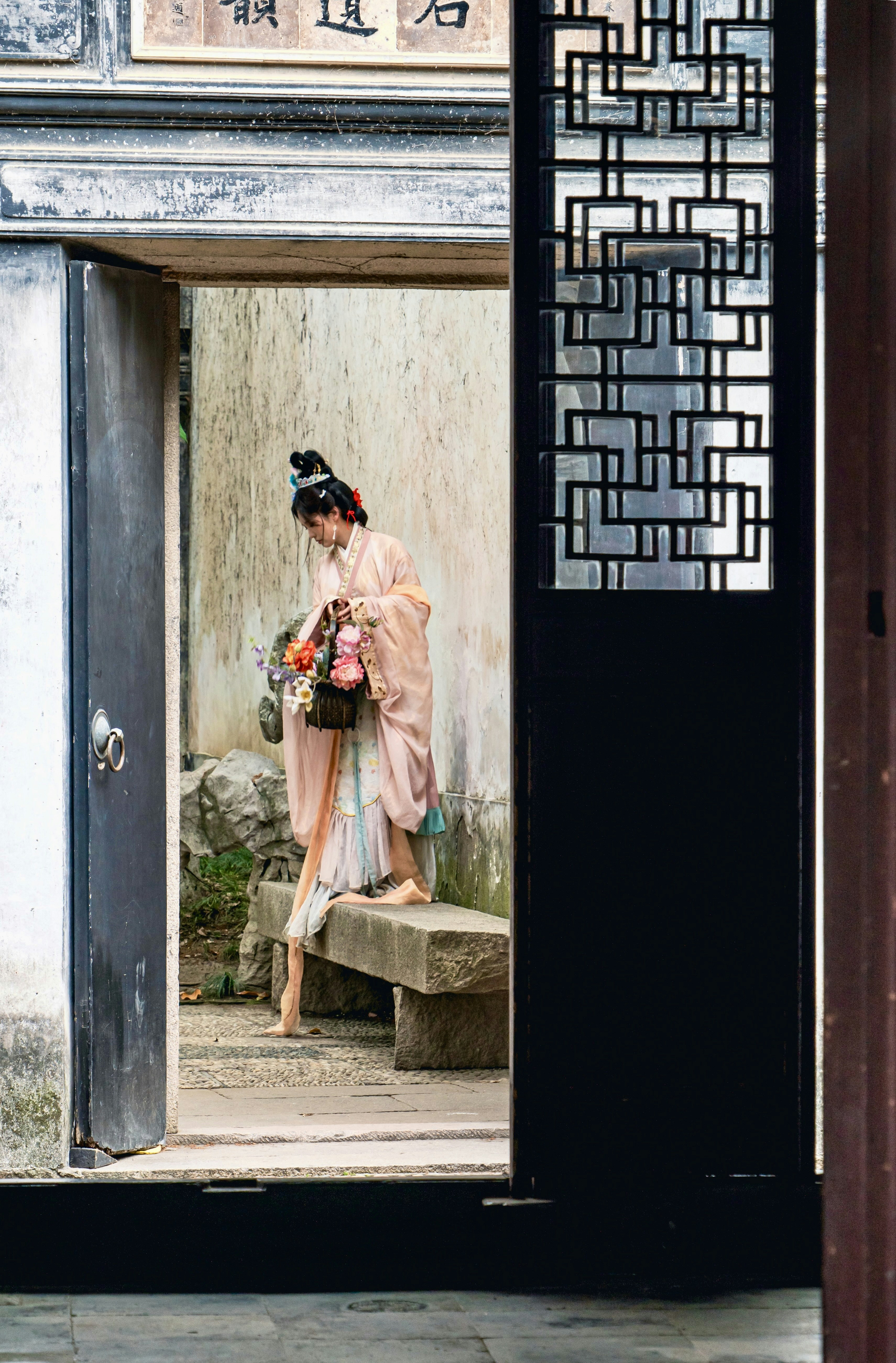 Soft Elegance in a Quiet Courtyard: A Geisha at the Threshold