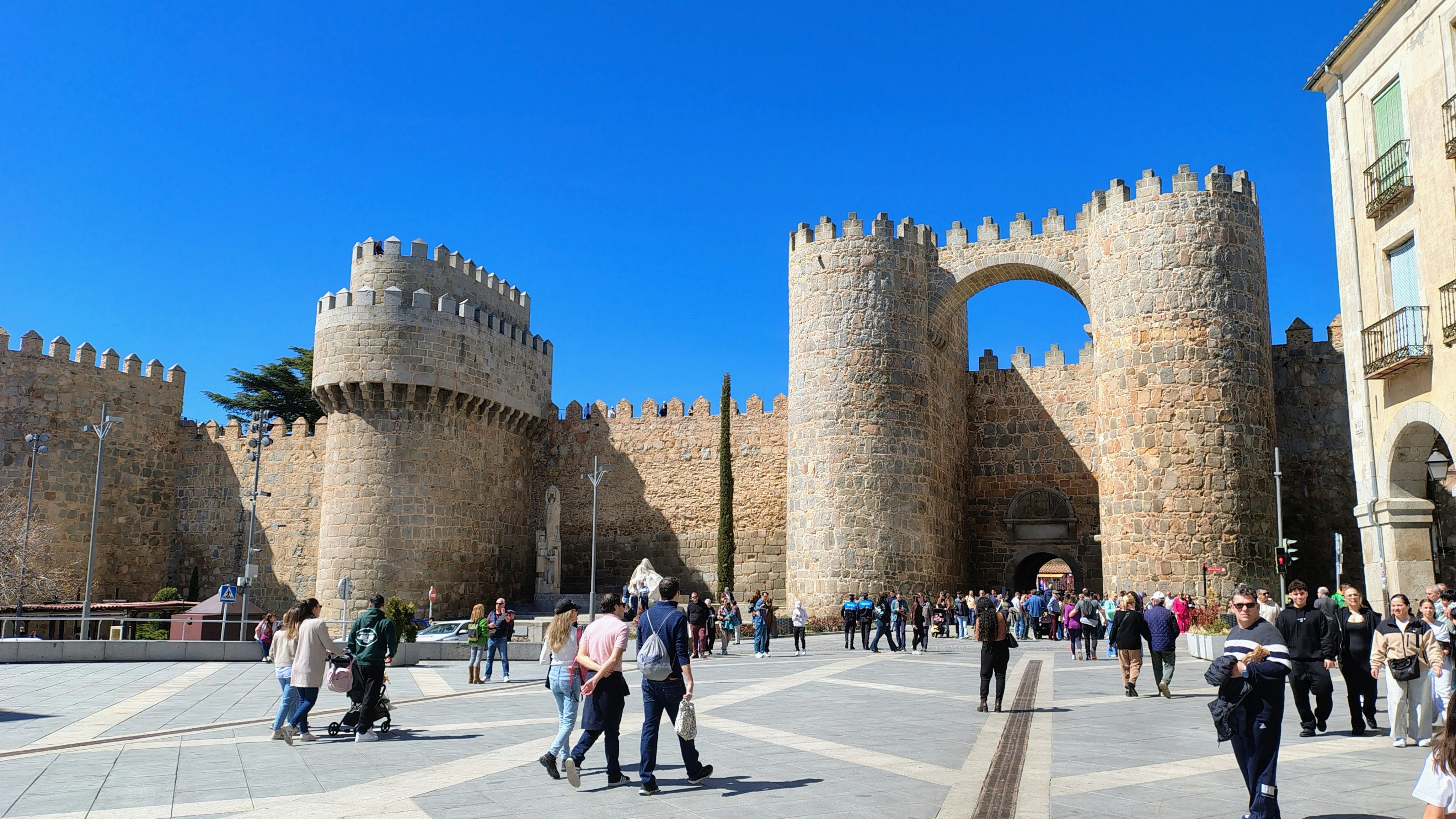 Gateway of the Castle: A Sunlit Plaza Under Towered Walls