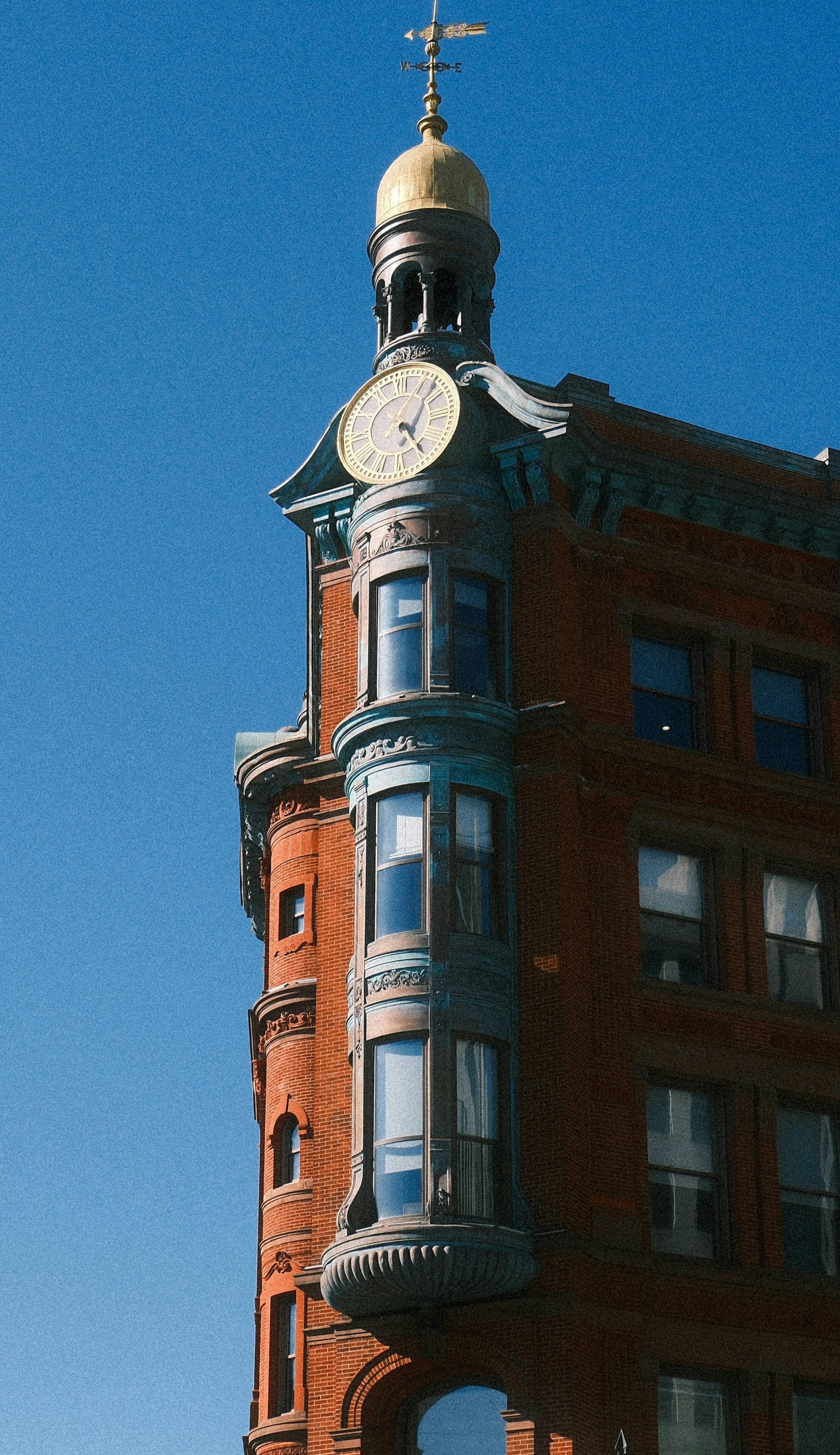 Clock Tower on a Blue Day: A Historic Corner Reaches for the Sky