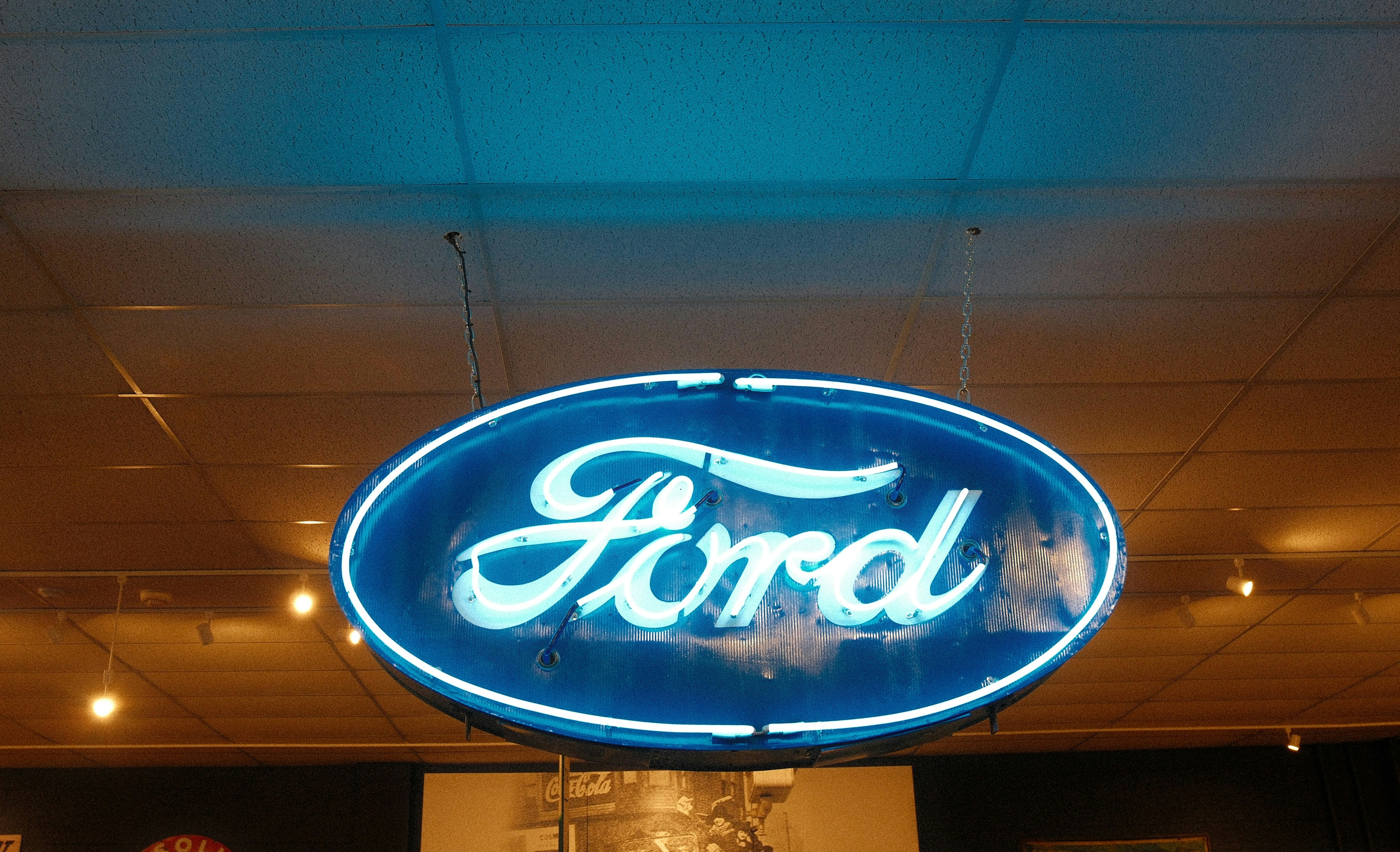 Glowing Ford Emblem Suspended Above a Dimly Lit Interior