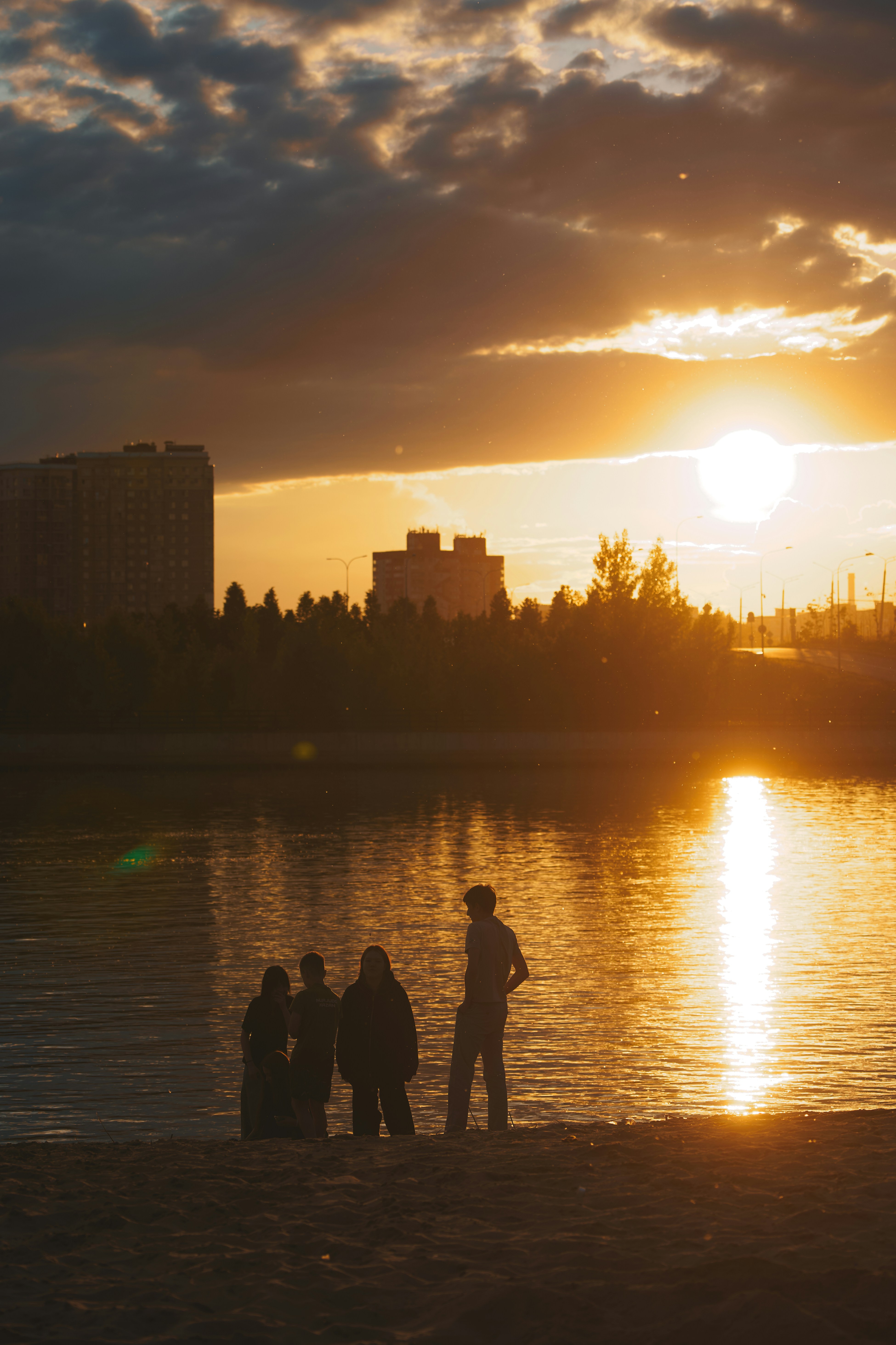 Sunlit silhouettes by the river at golden hour