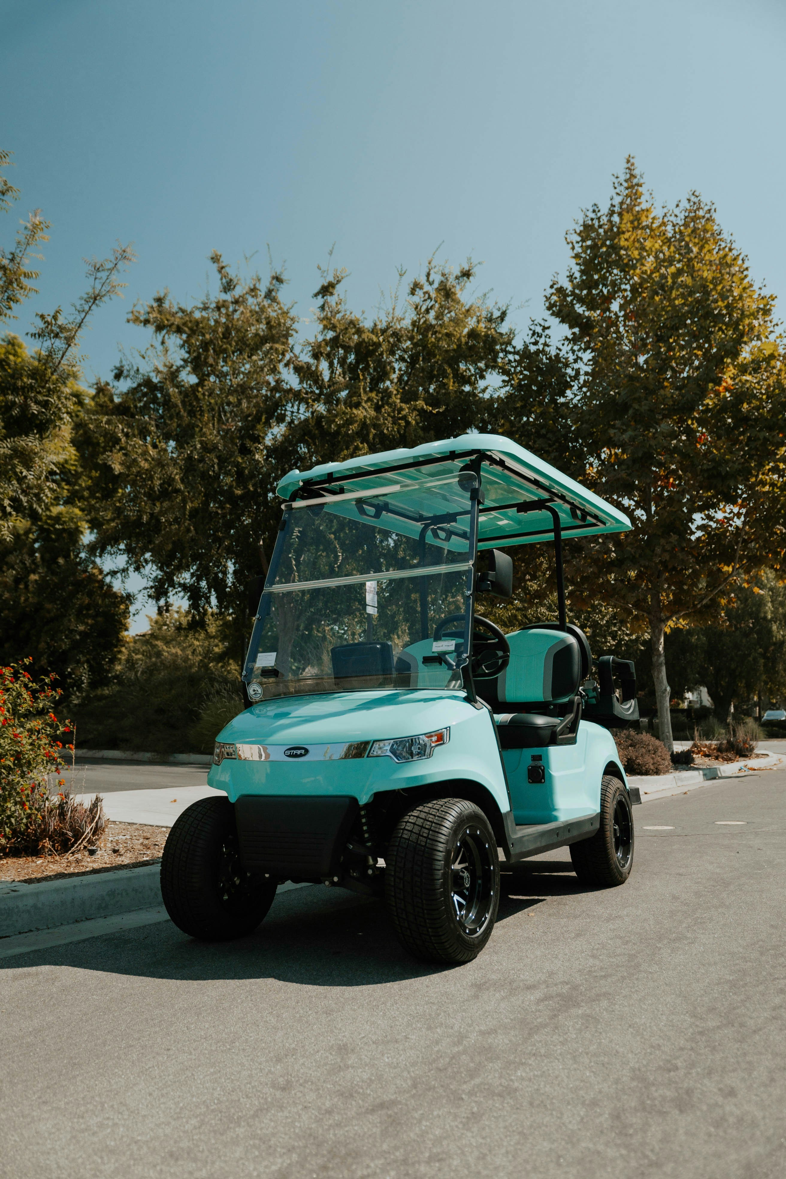 Mint-Turquoise Street Shuttle Resting Under a Shaded Sky
