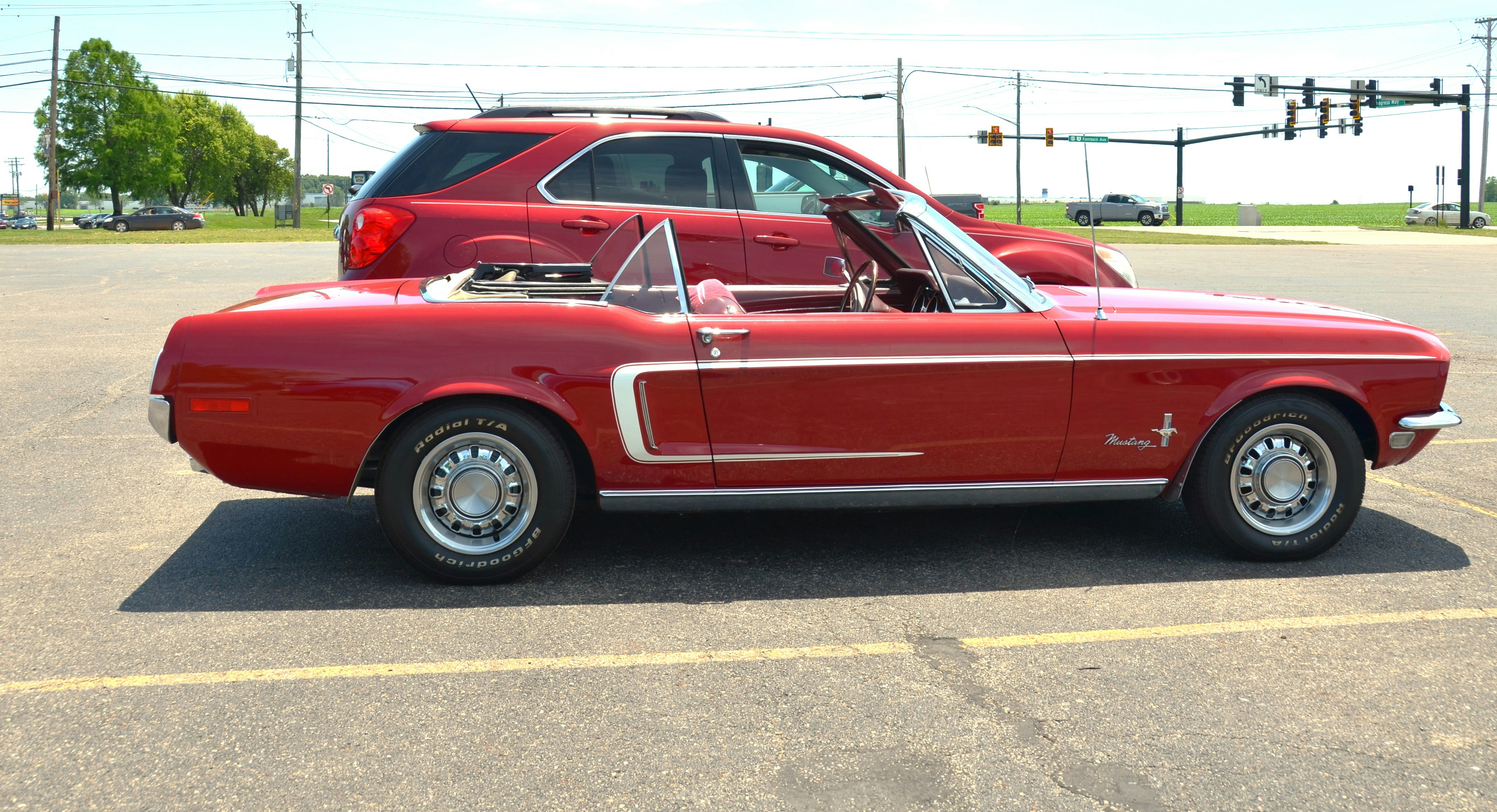 Crimson Convertible: A Sunlit Runabout in a Quiet Lot