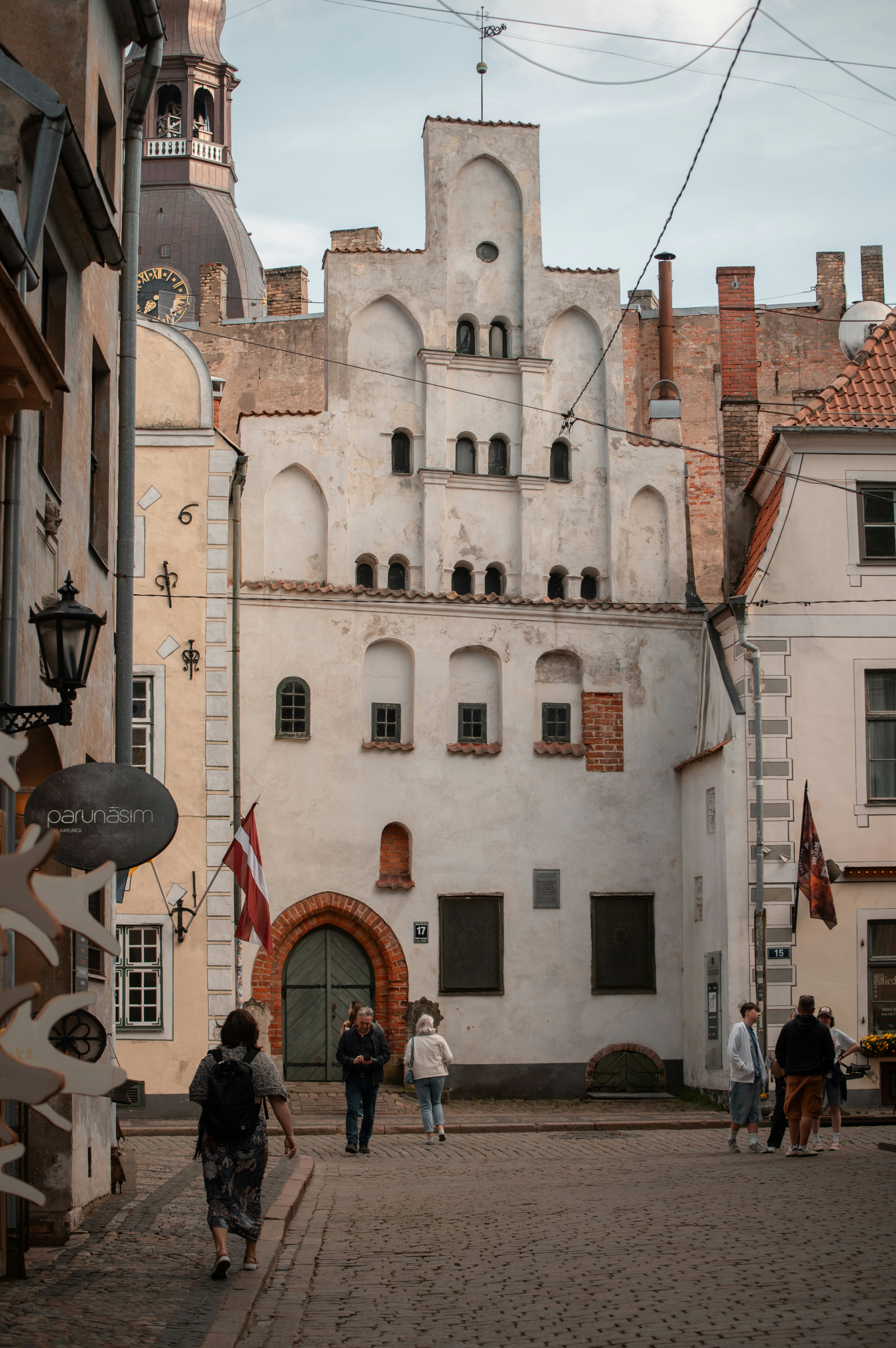 Facade of a Historic Town Center with Passersby
