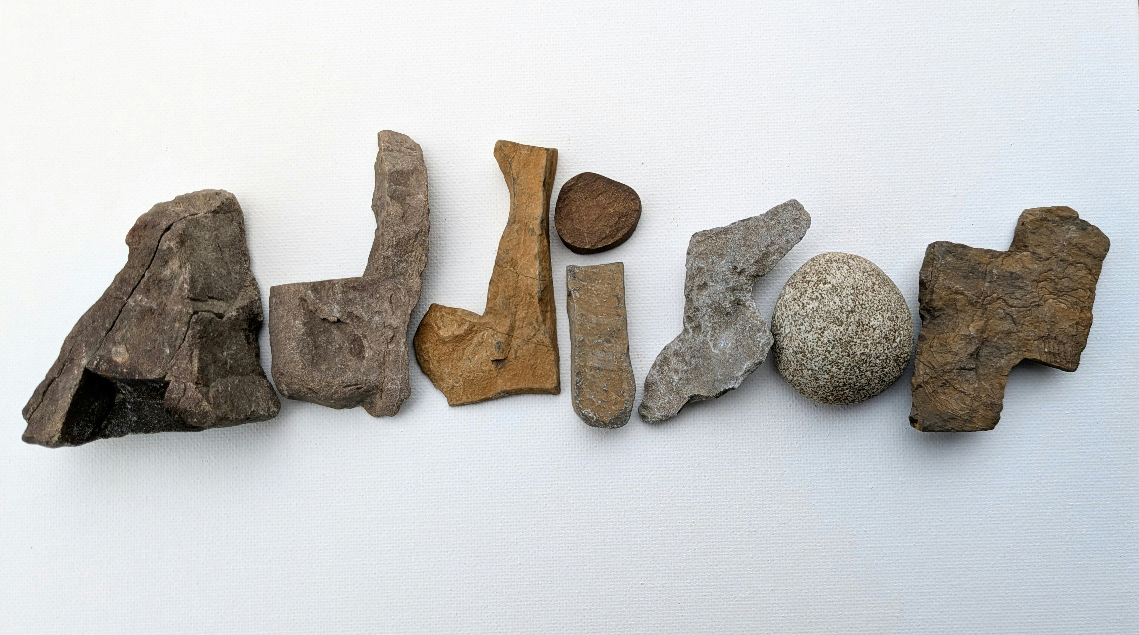 An arrangement of naturally fractured stones (found in Kananaskis, Alberta) spelling out a name.