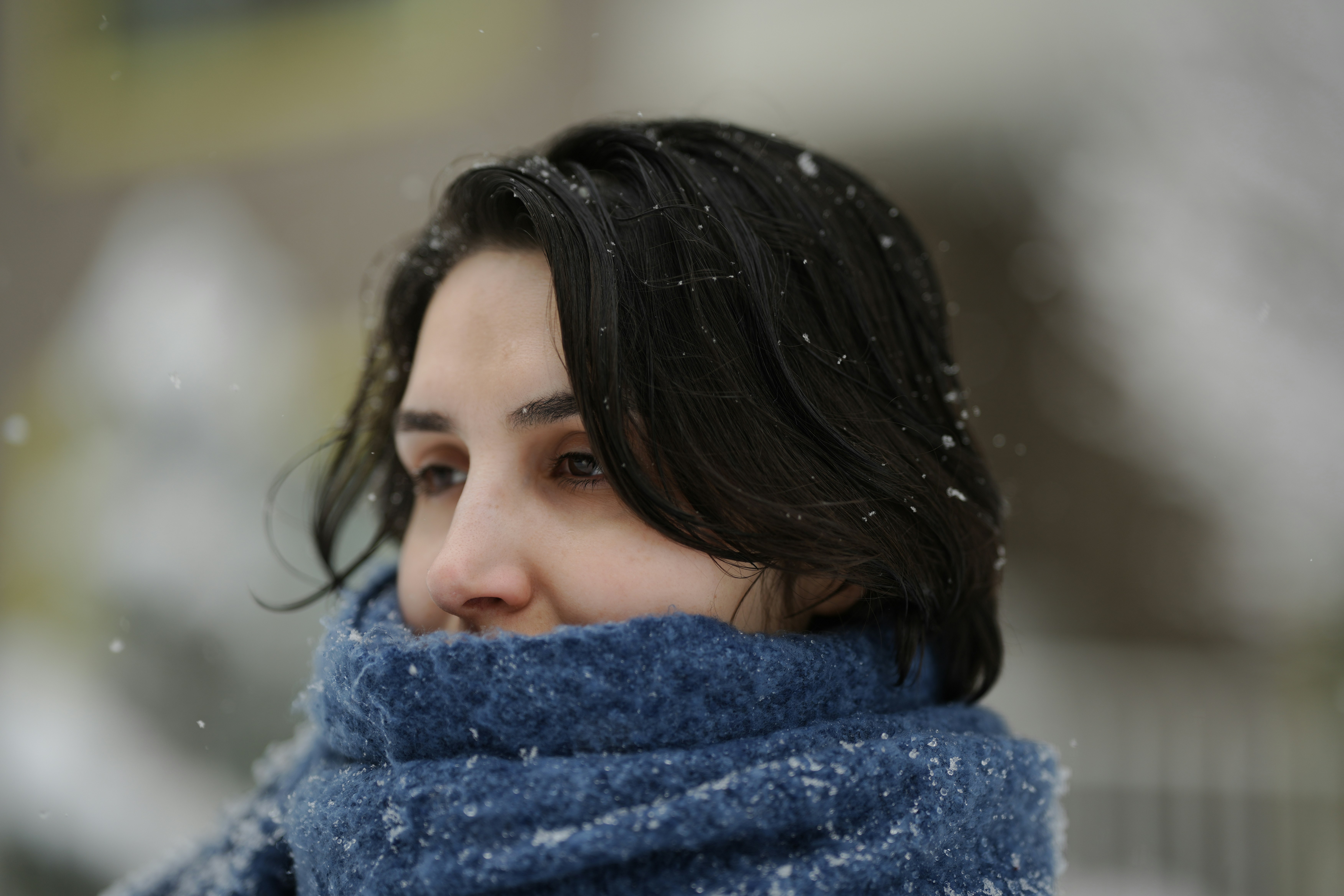 Snowfall Quietly Framing a Woman in a Woolen Blue scarf