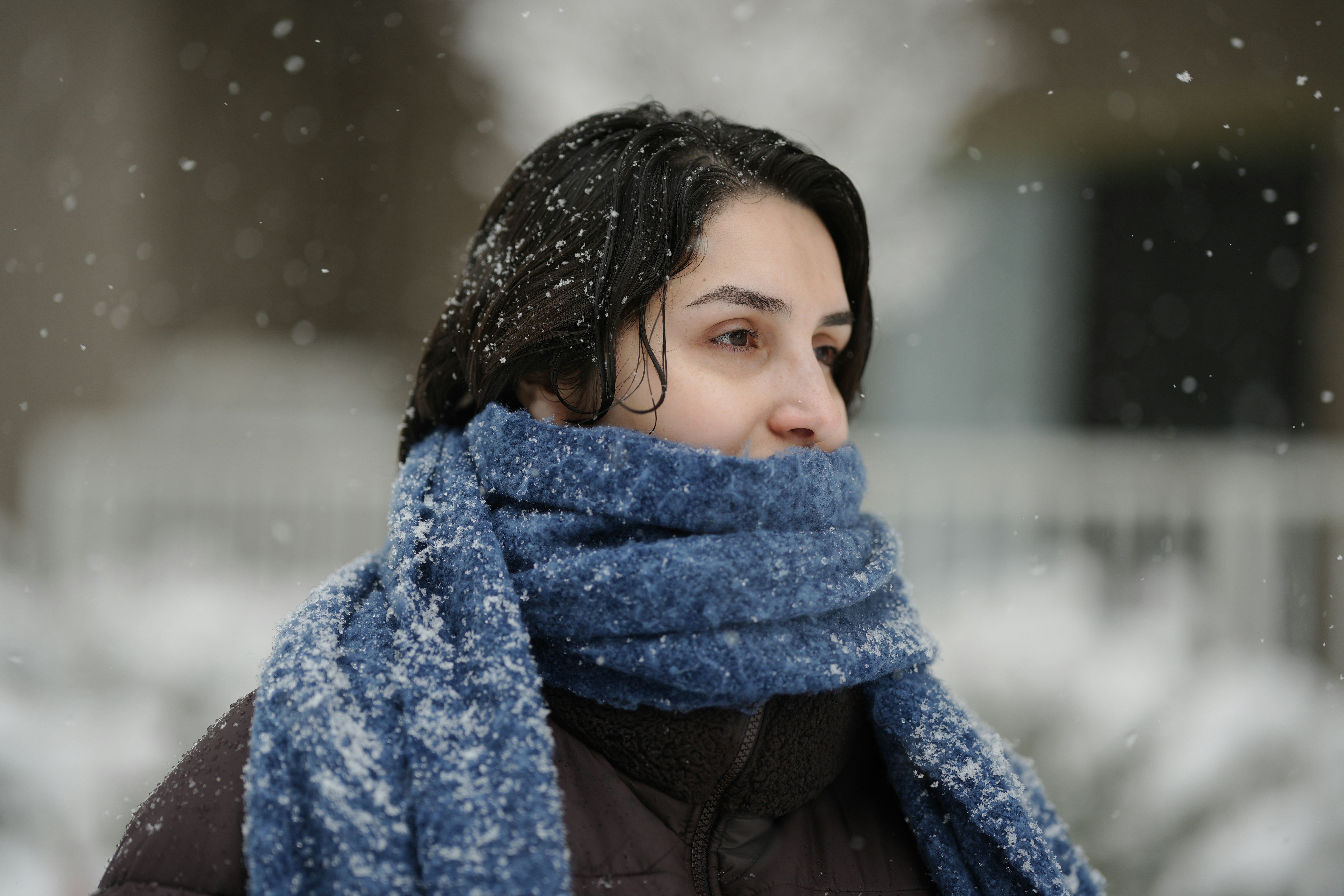 Winter Whisper: A Woman Wrapped in Snow-kissed Scarf
