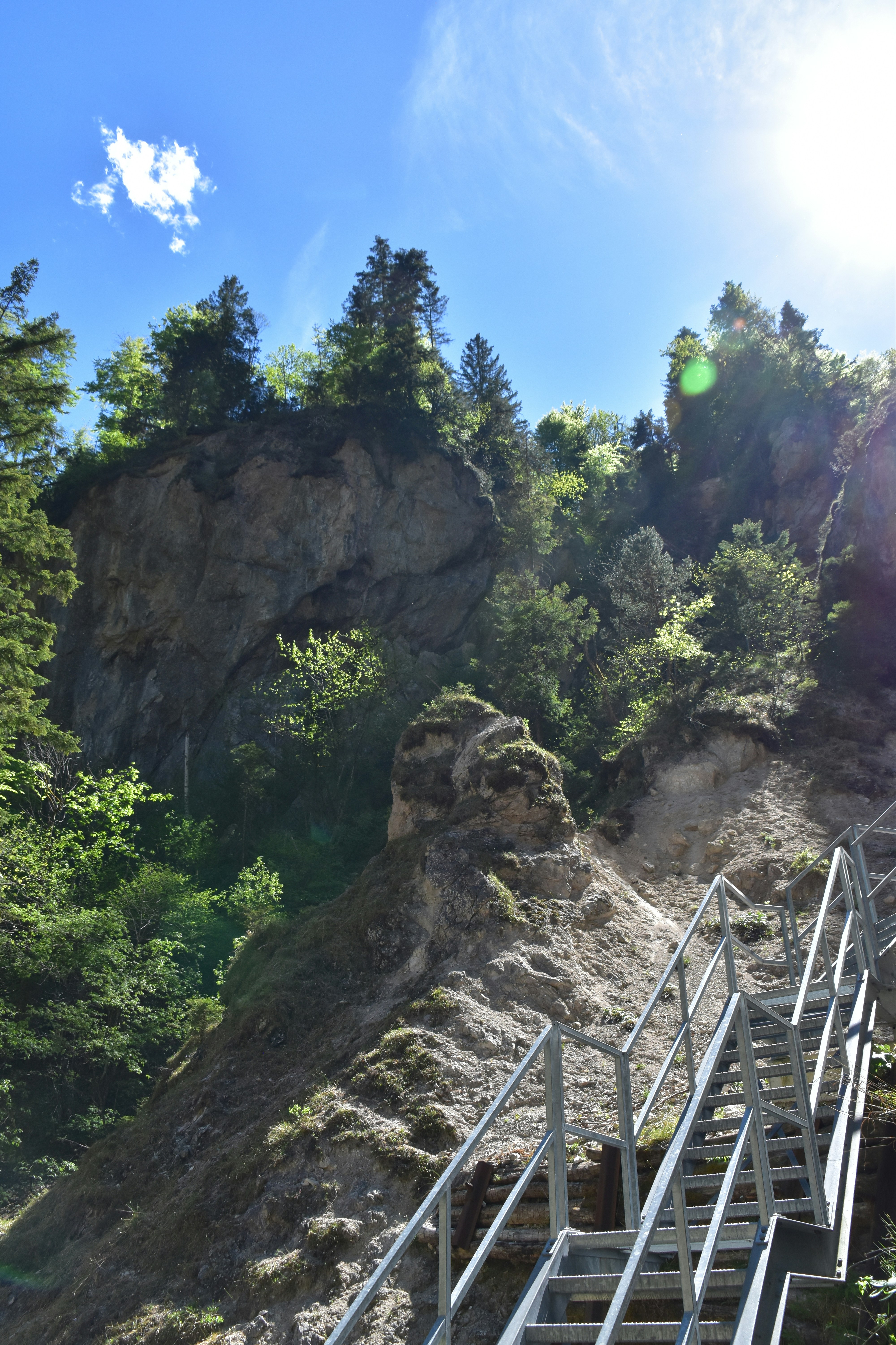 Sunlit Ridge Overlook: Staircase Tracing a Valley Cliff