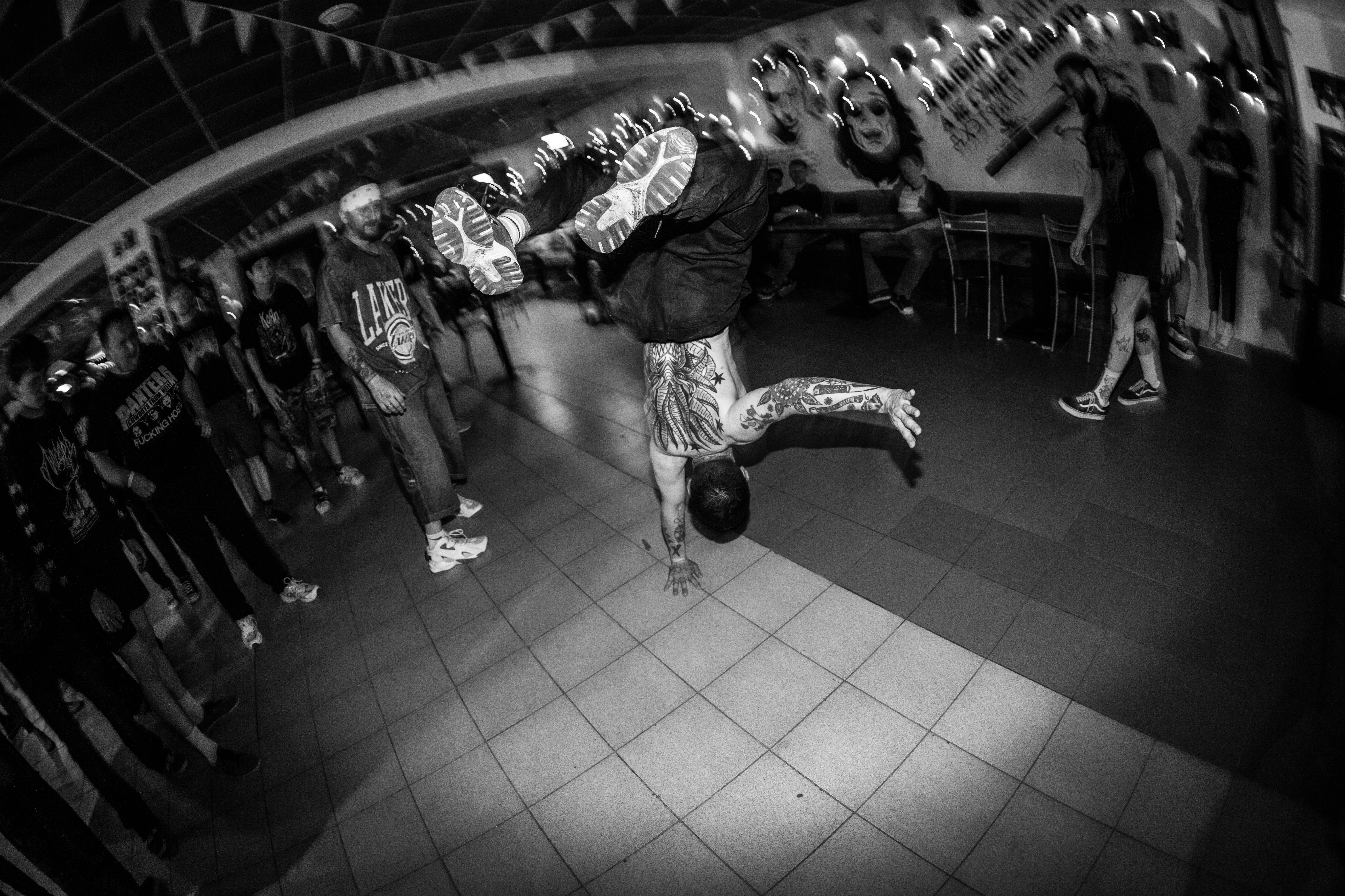 Mid-air flip over a cheering crowd in a crowded venue