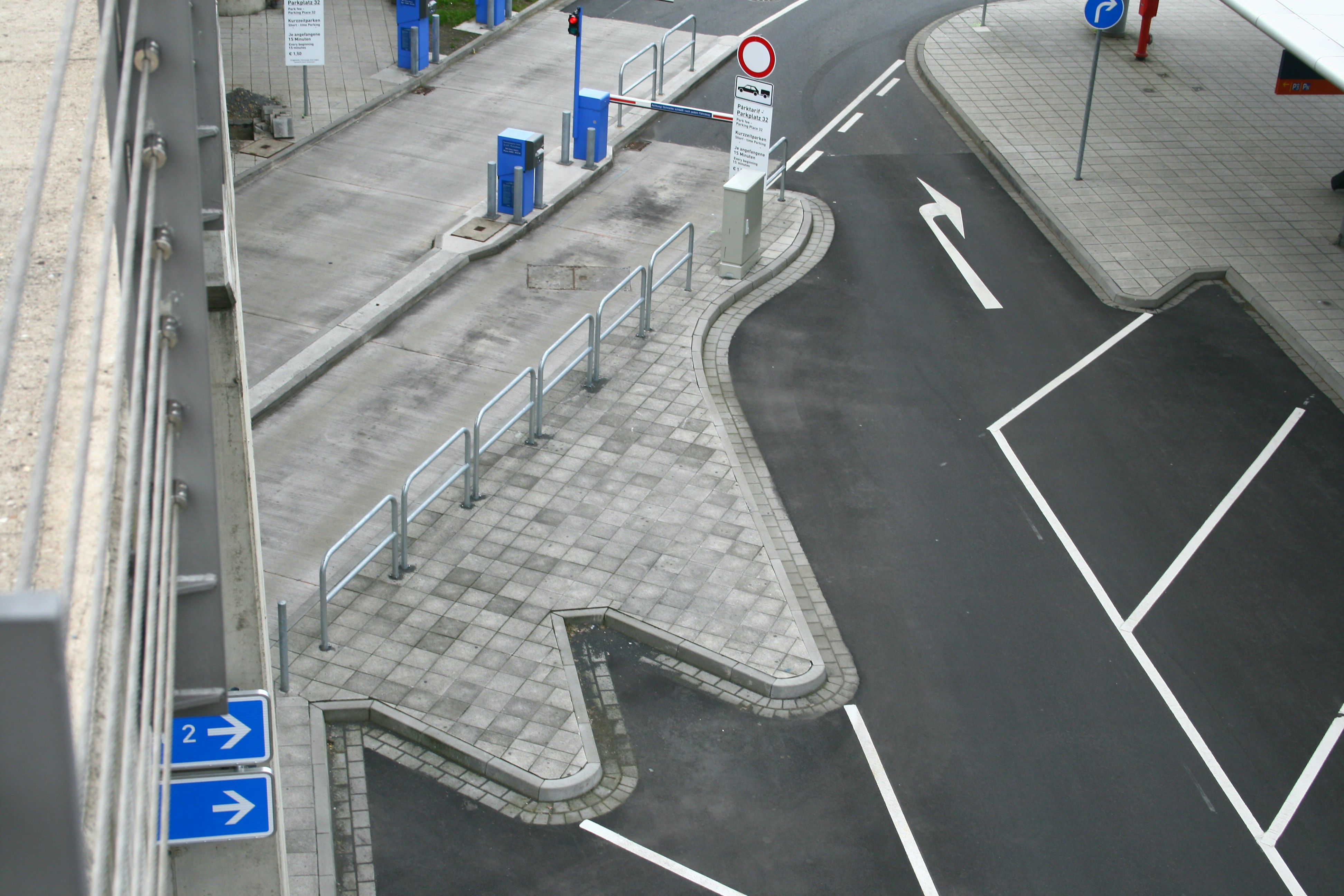 Urban corridor: stepped terrace meets curved curb and road markings