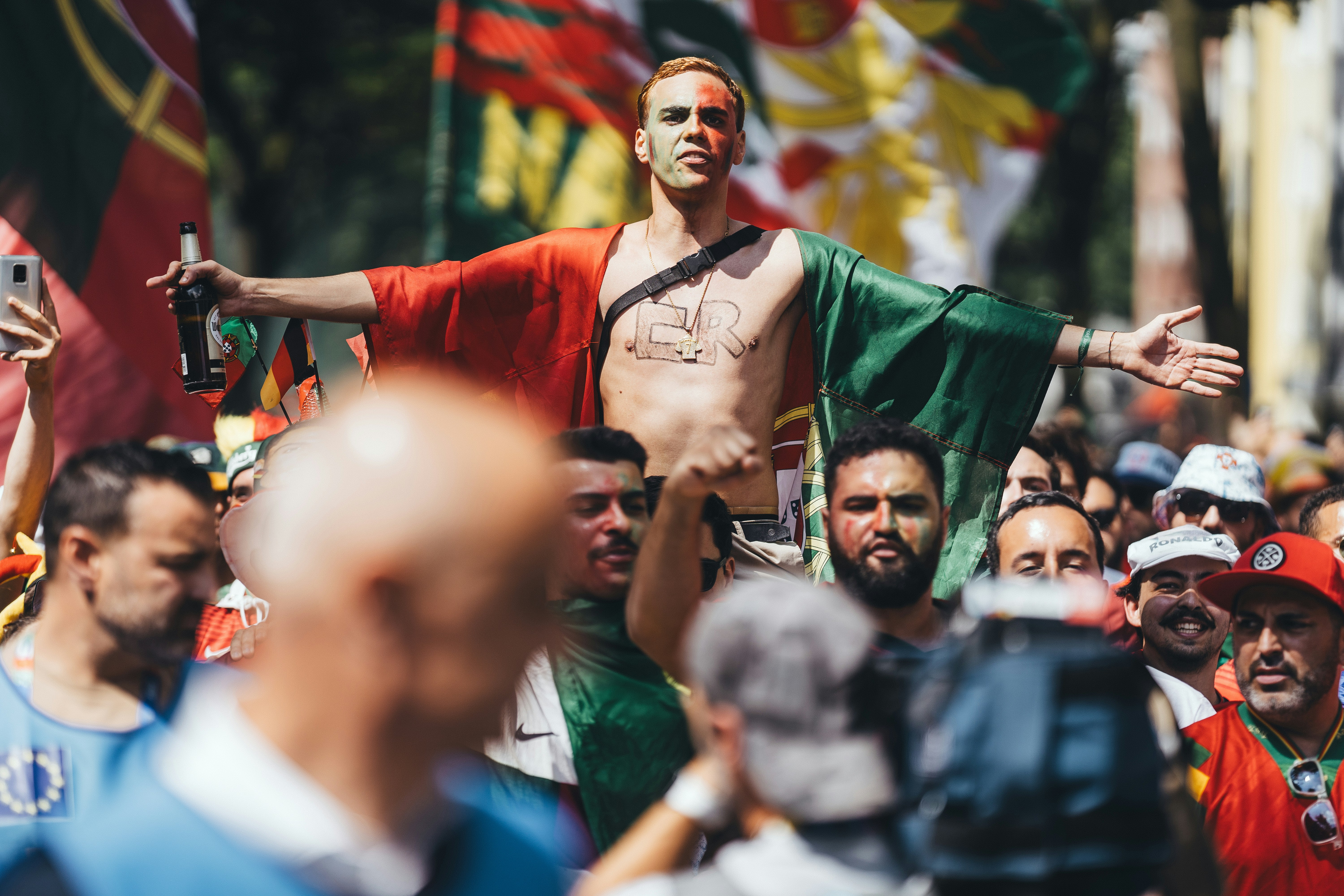 Flag-bearer Above the Crowd: A Prideful Moment in the Parade