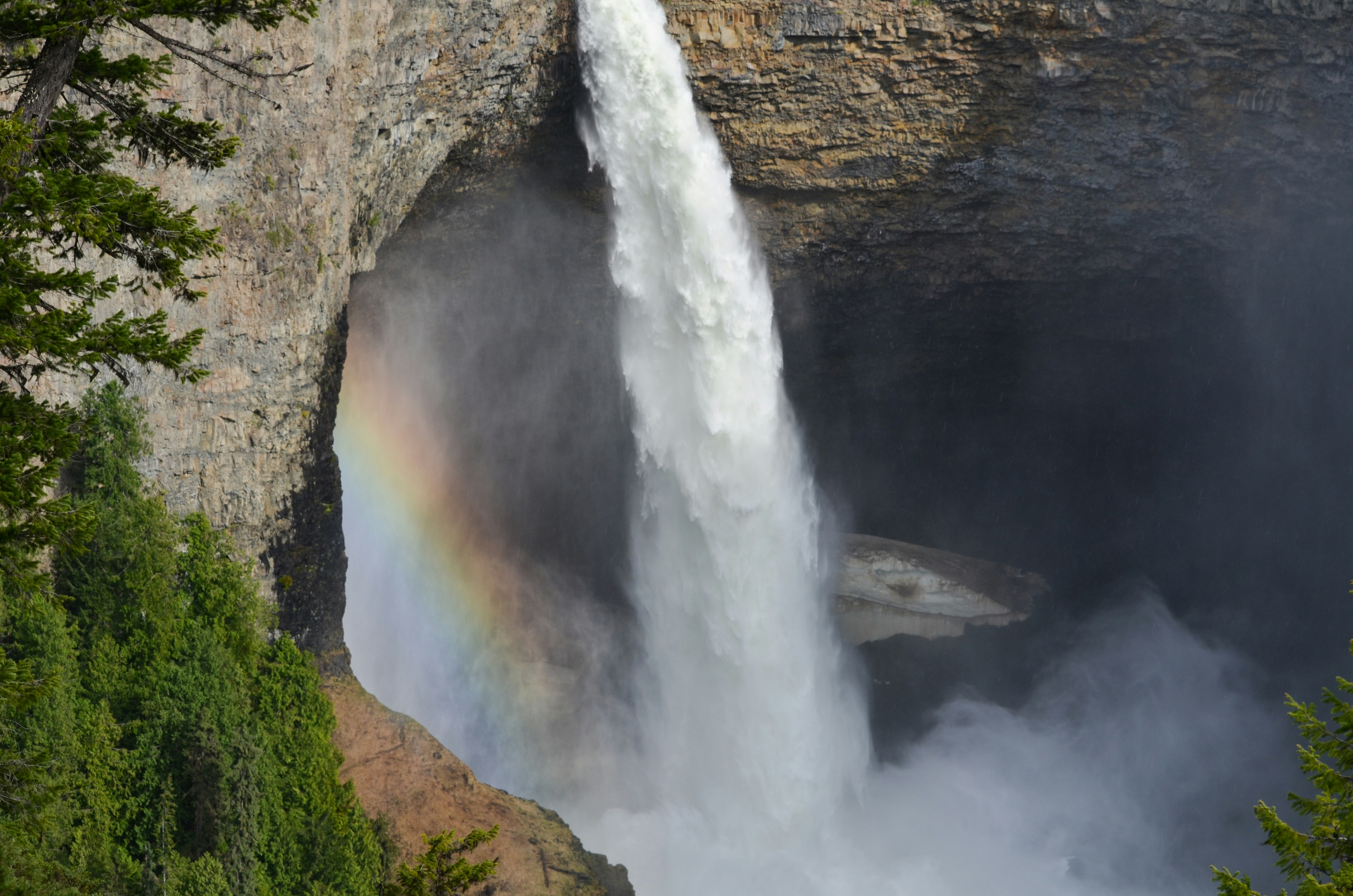Mist Ribbon of Power: A Cascade Against Canyon Cliffs