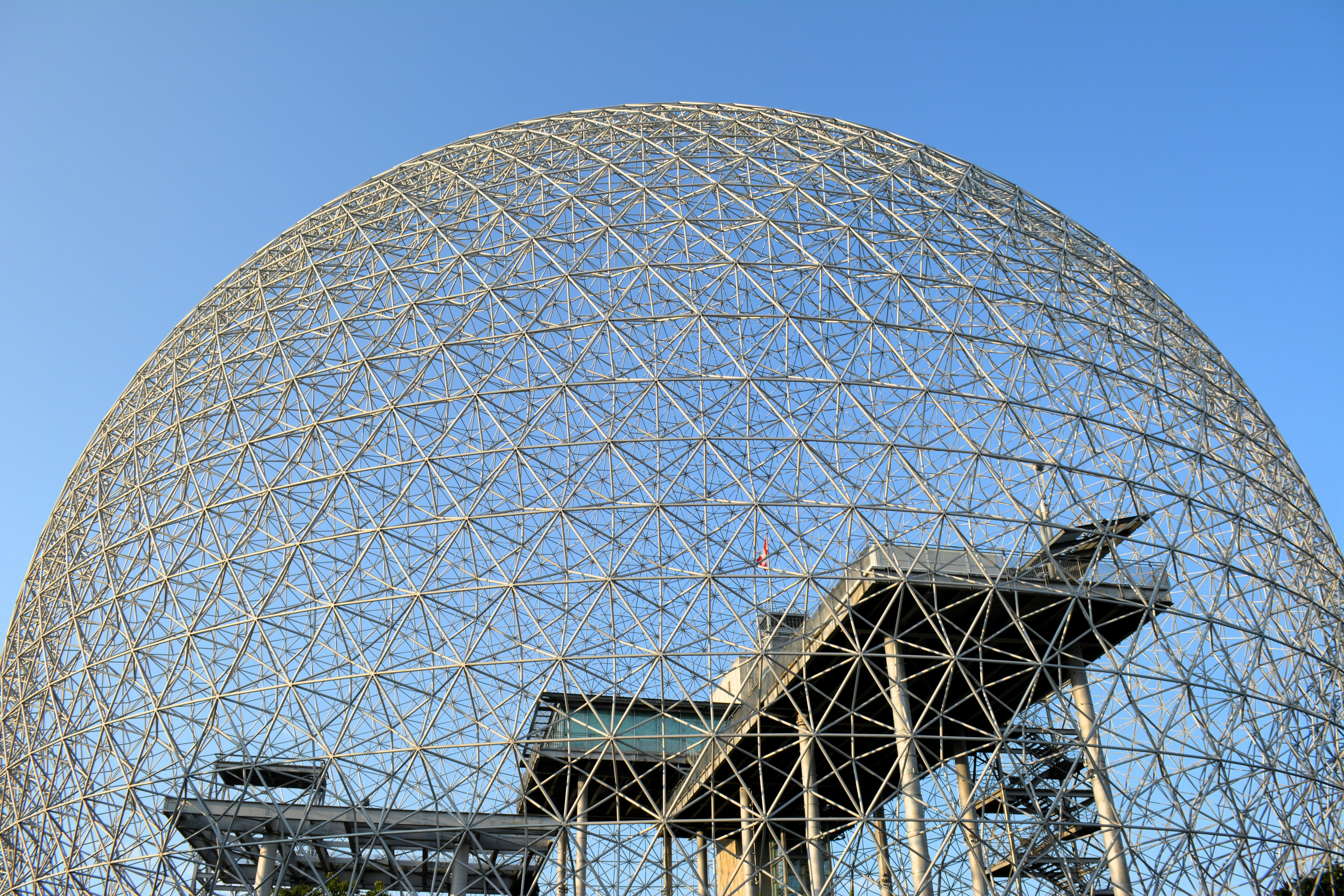 Geodesic Dome Overlook: Structural Mesh Against a Clear Sky
